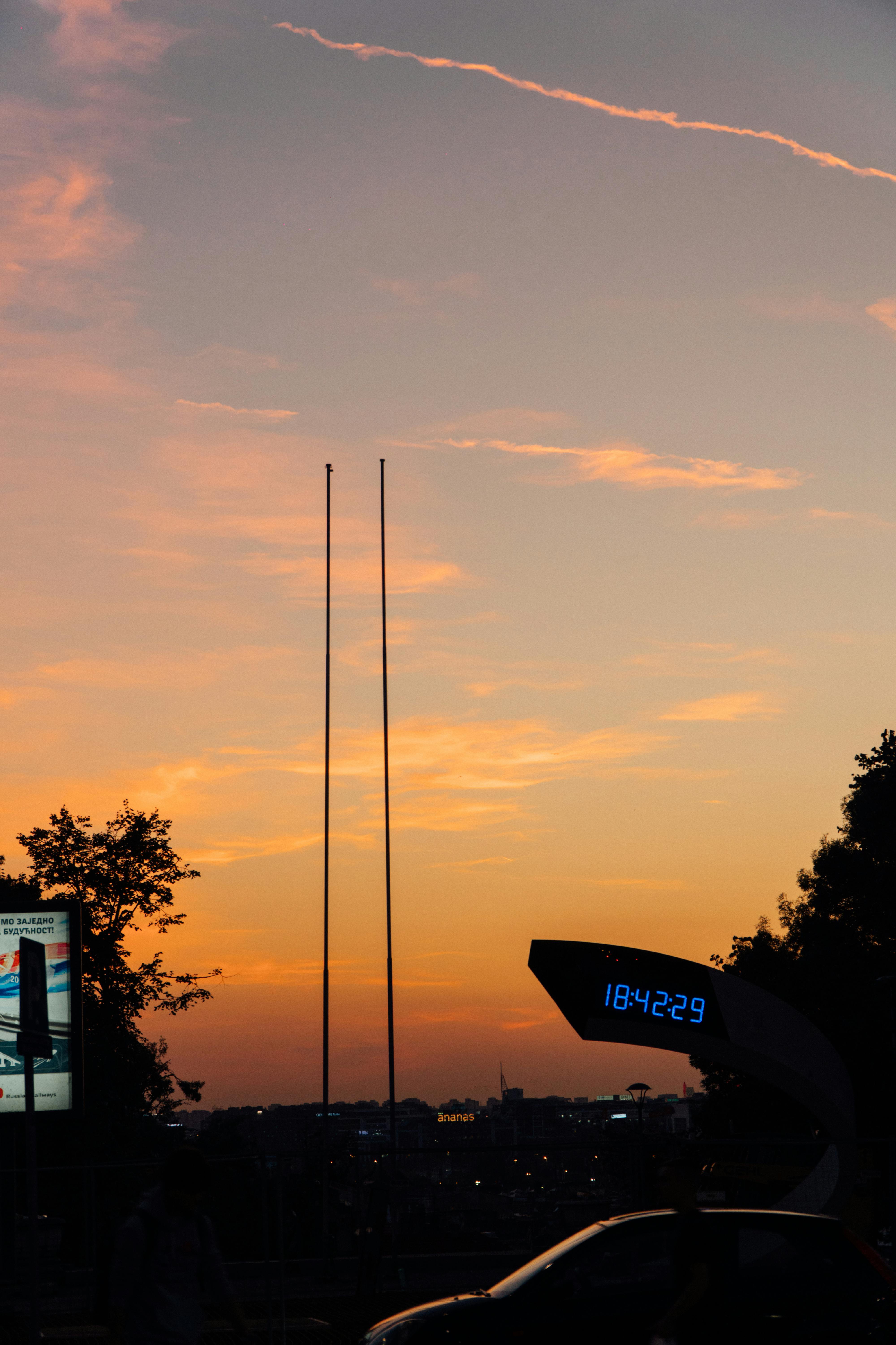 Two Tall Poles Standing against the Sky at Dusk · Free Stock Photo