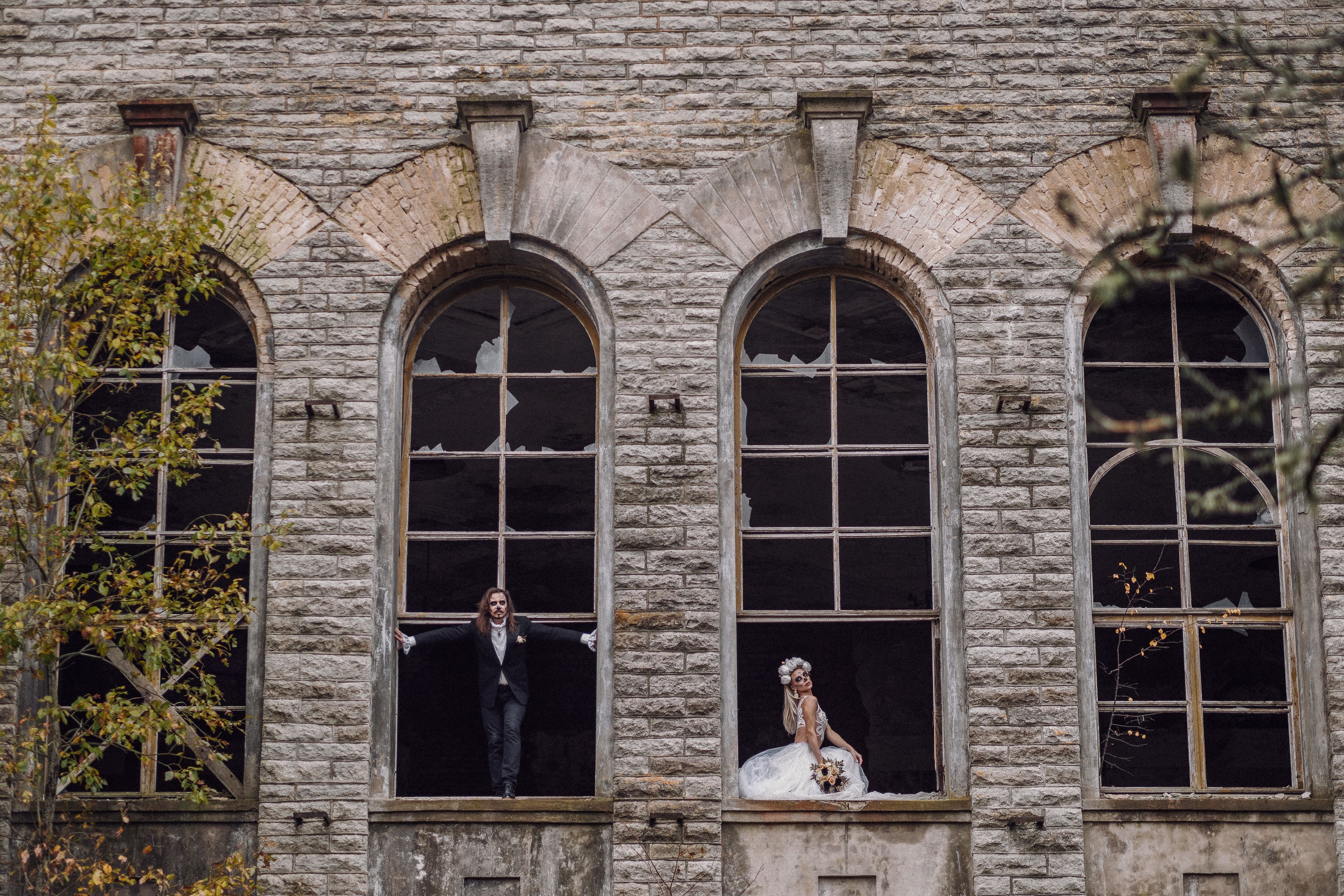 Bride and Groom in Windows of Abandoned Building Celebrating Halloween ...