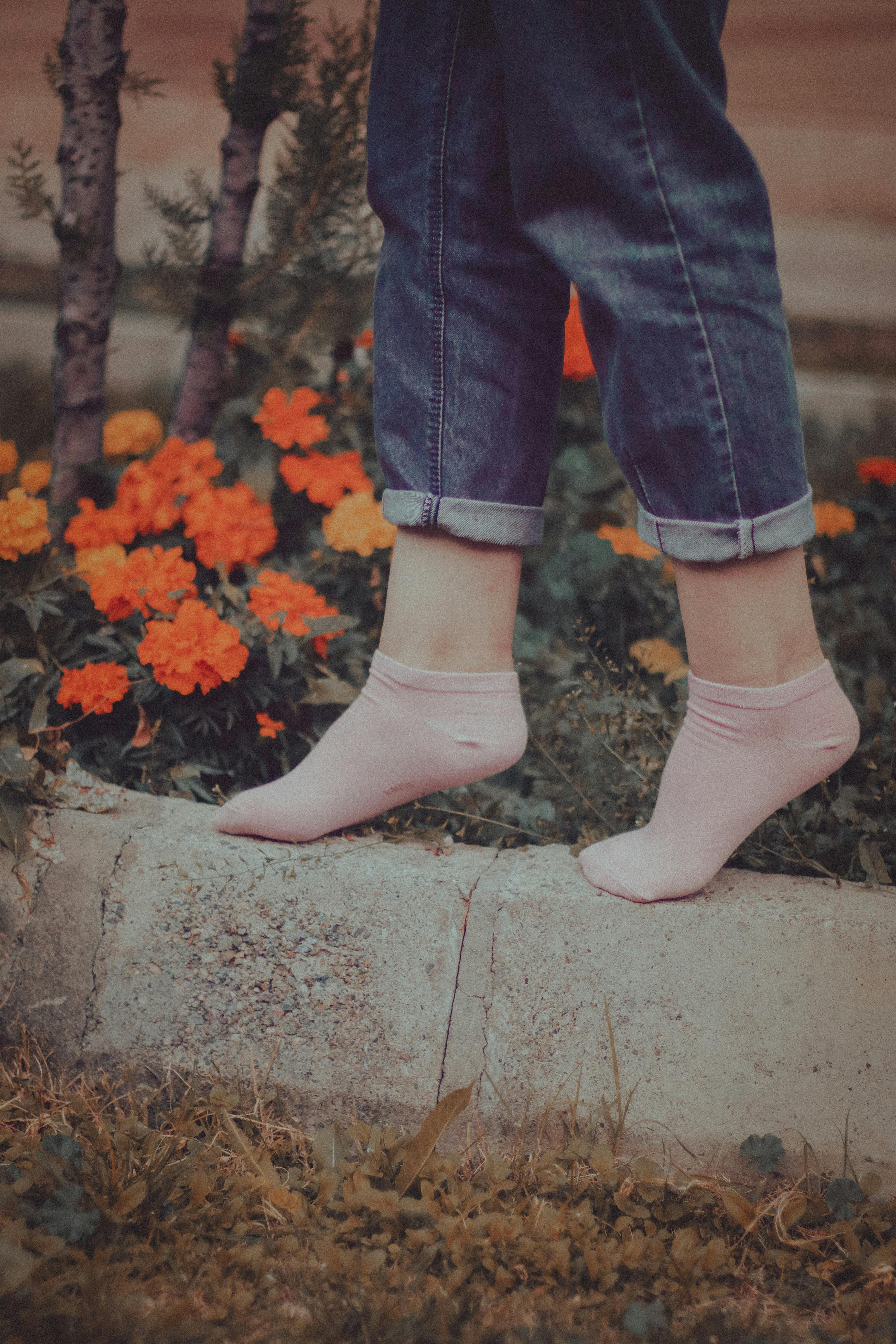 A person in pink socks standing on a ledge · Free Stock Photo
