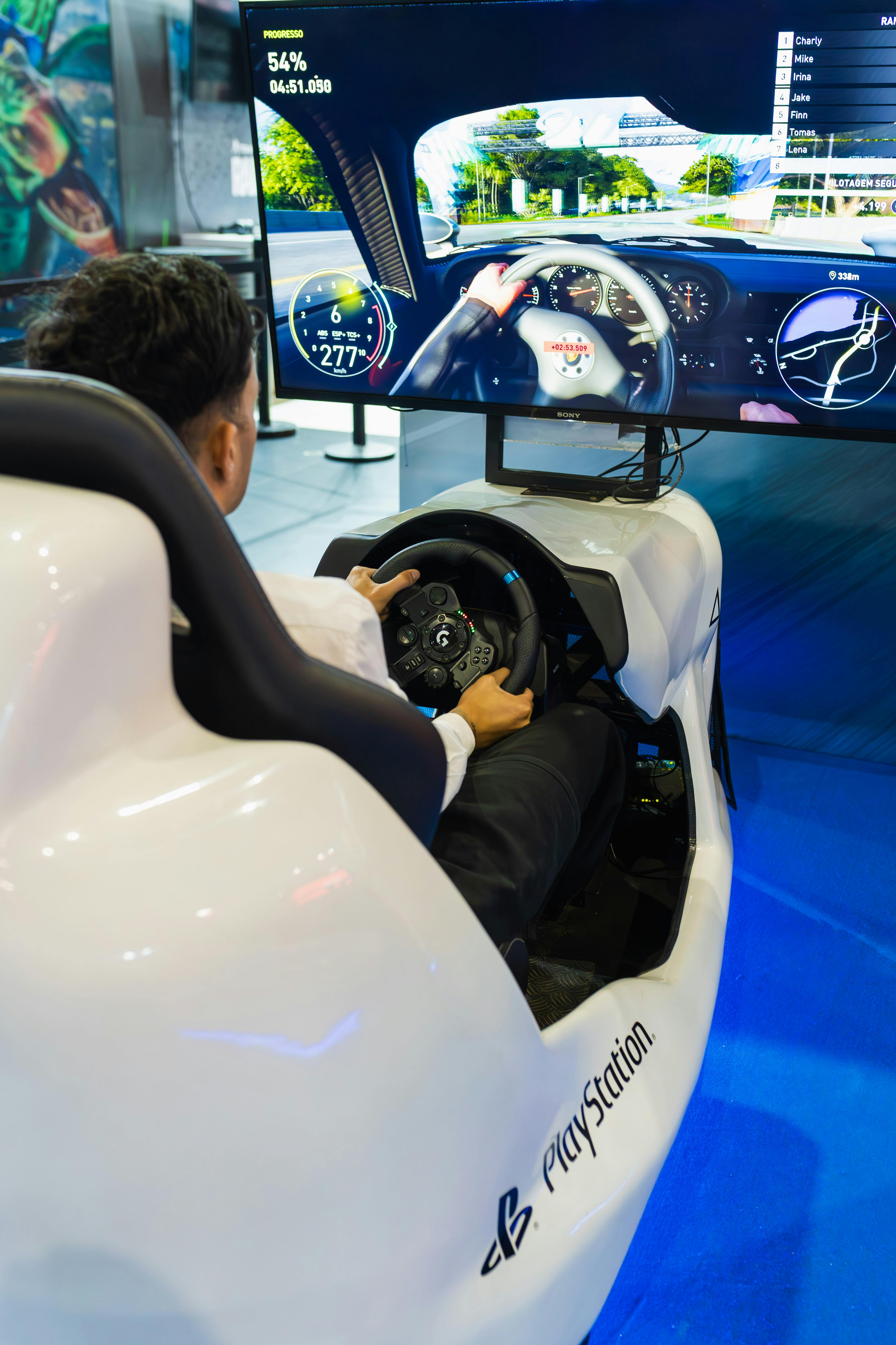 Man Playing Racing Game on a Sony PlayStation Simulator with a Logitech ...