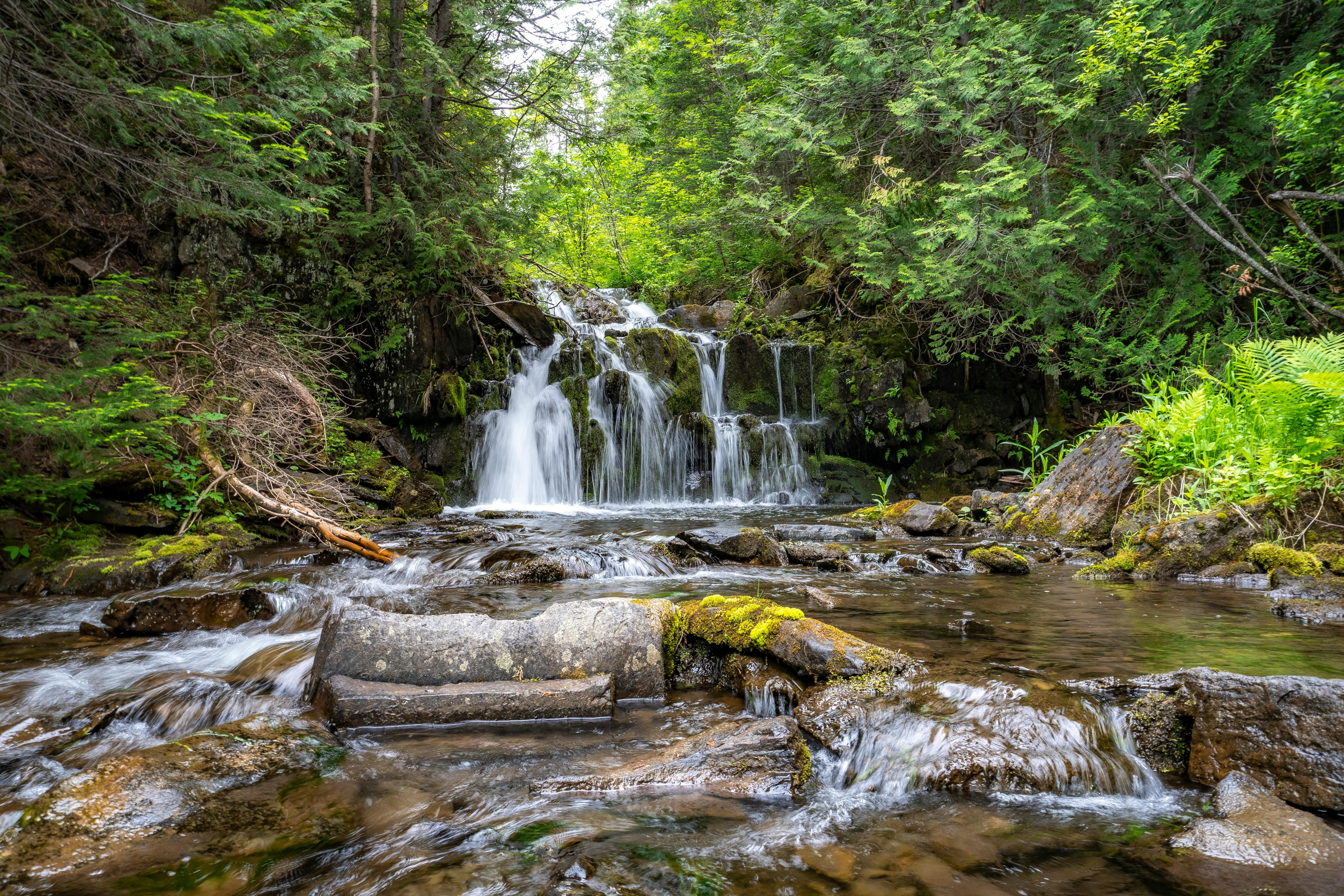 Downstream Waterfall on Black Rocks during Day · Free Stock Photo
