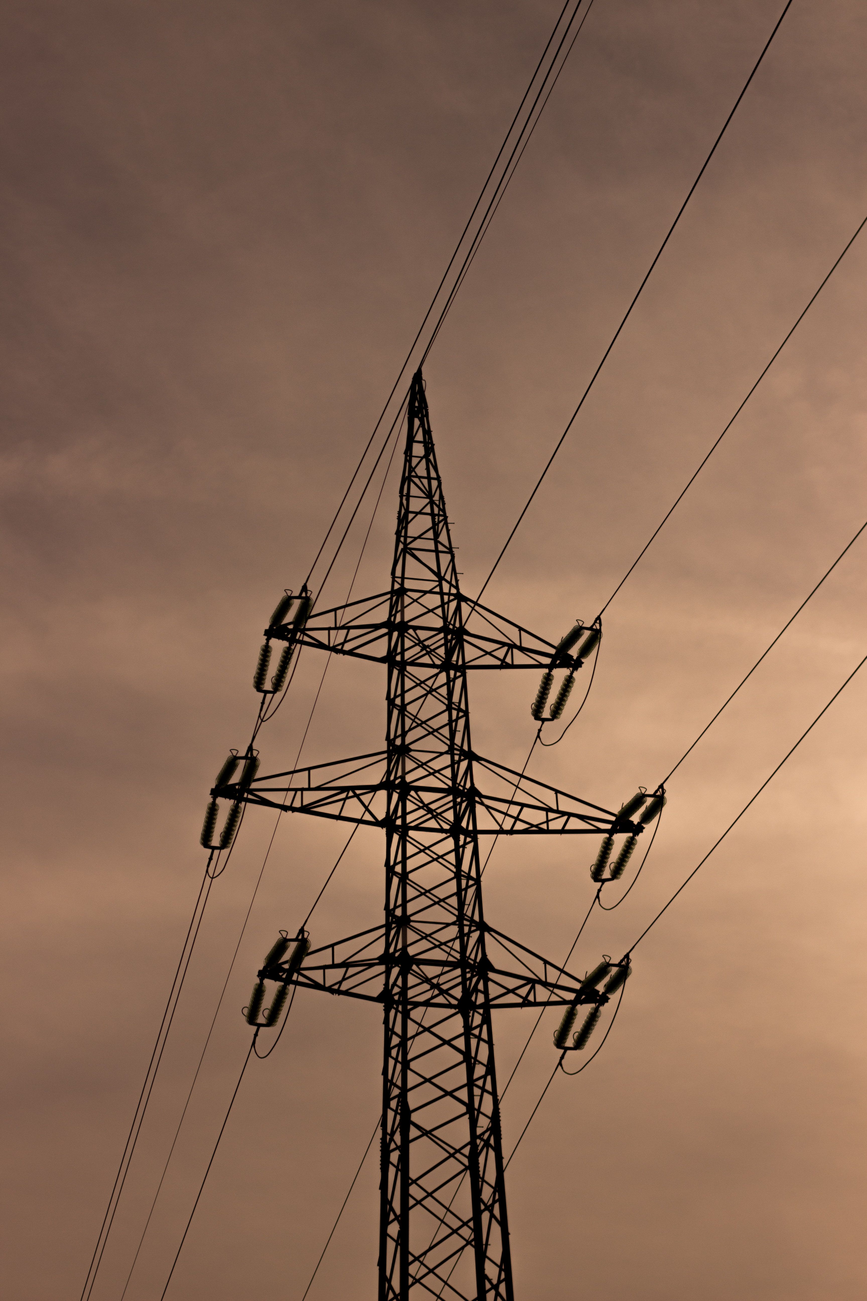 Electricity Pylon Standing against the Sky at Dusk · Free Stock Photo