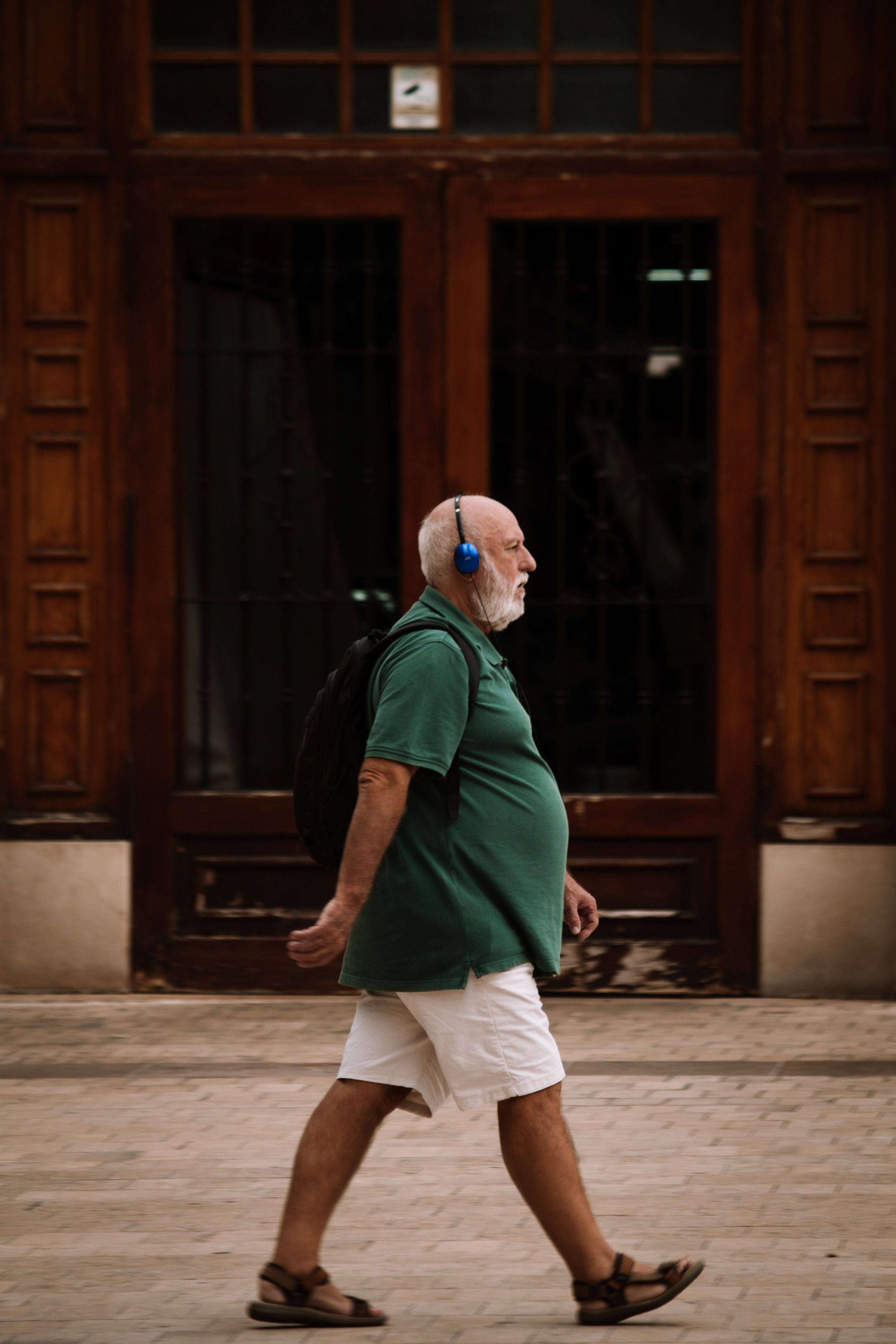 Elderly Man in Green T-Shirt and White Shorts on Street · Free Stock Photo
