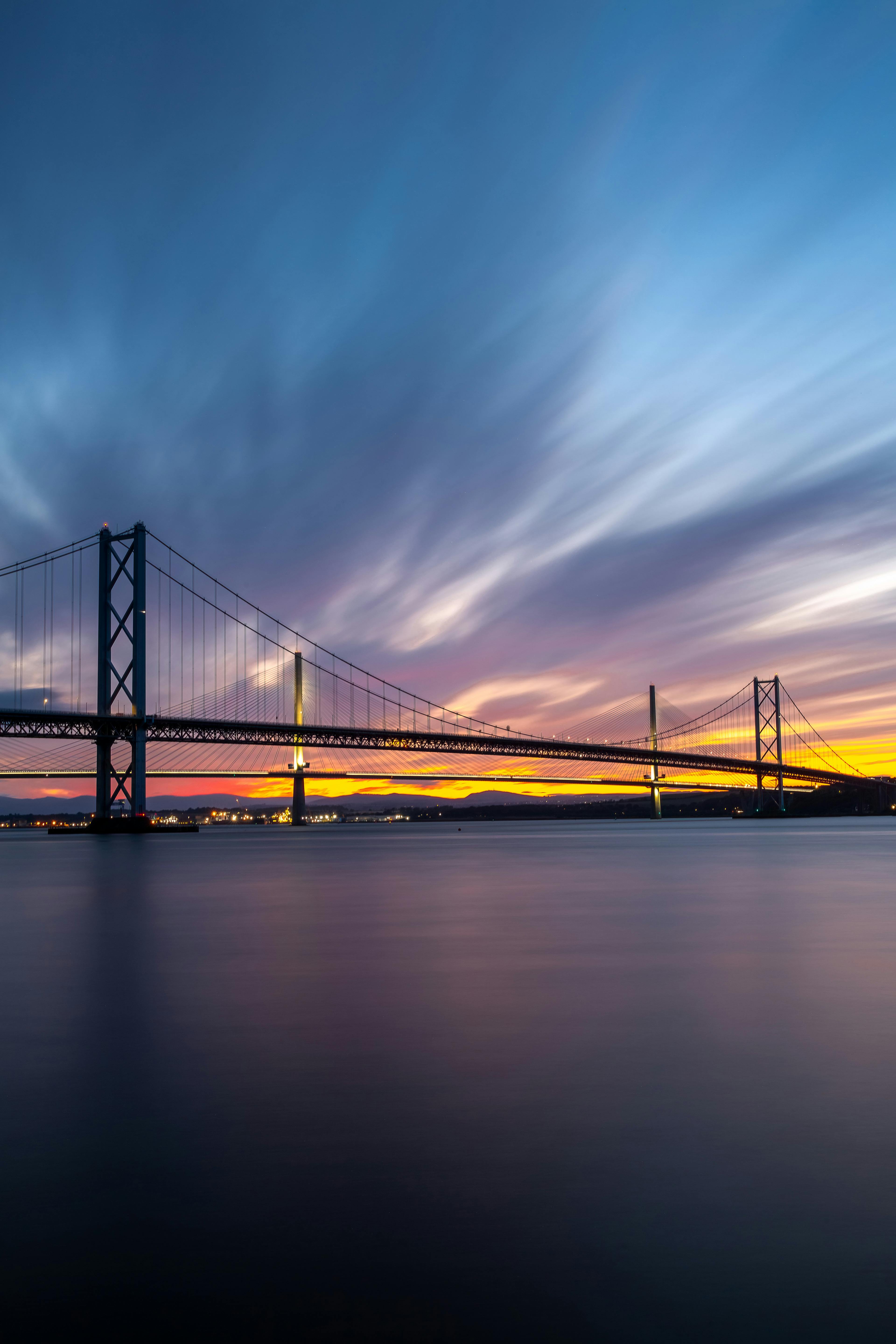 A Suspension Bridge Under the Blue Sky and White Clouds · Free Stock Photo
