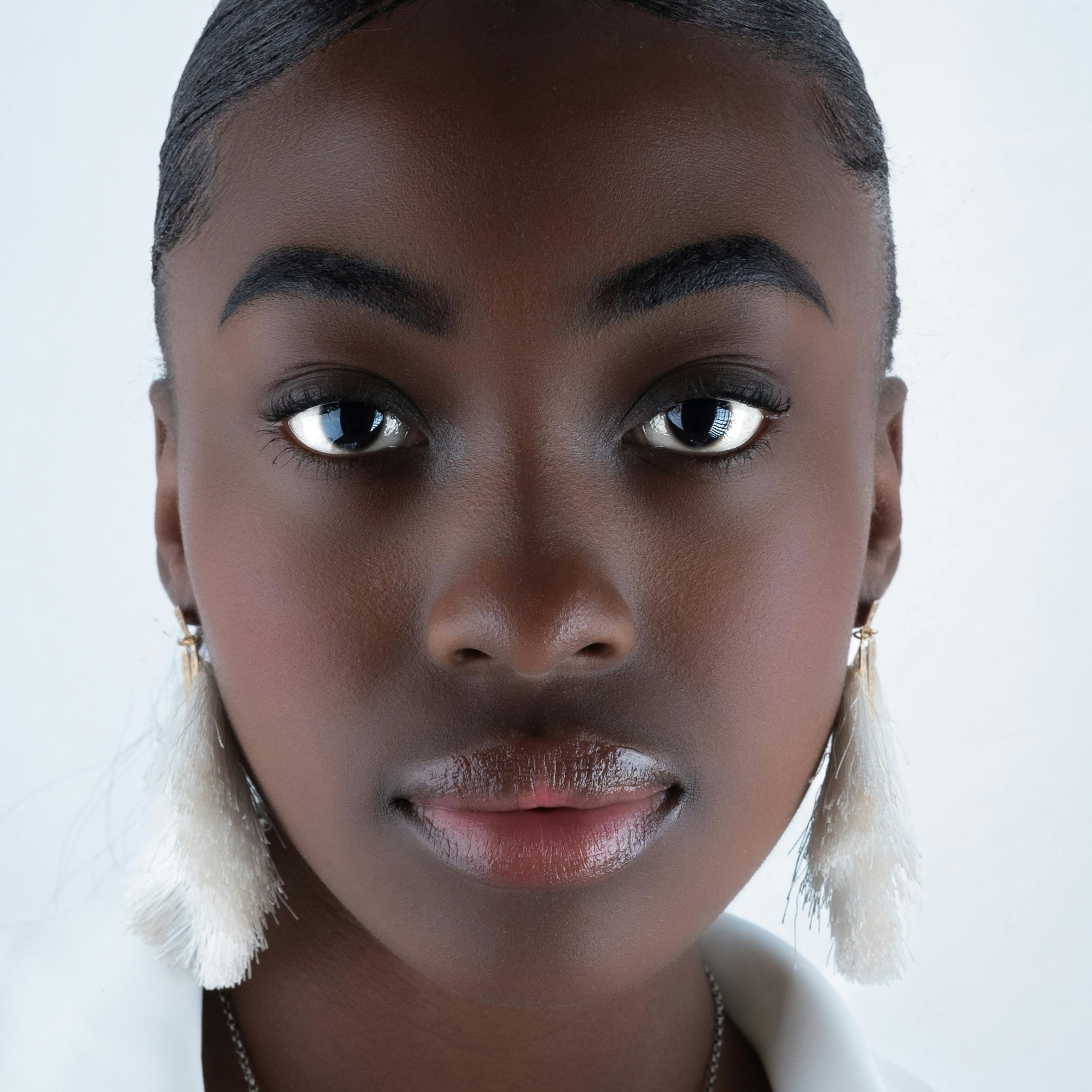 Close-up Portrait of a Woman Wearing Dangle Earrings · Free Stock Photo