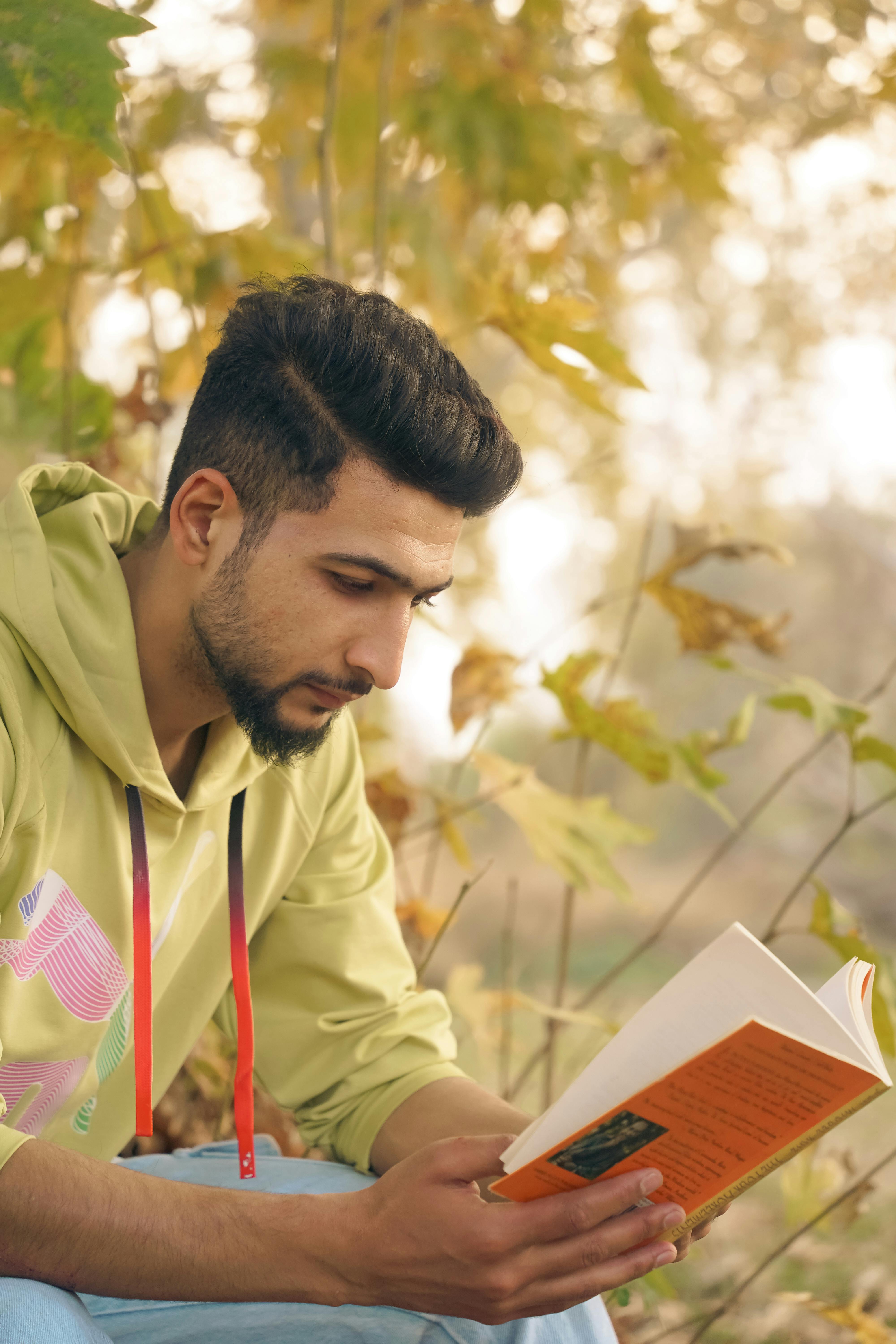 Man Reading Book in a Park · Free Stock Photo