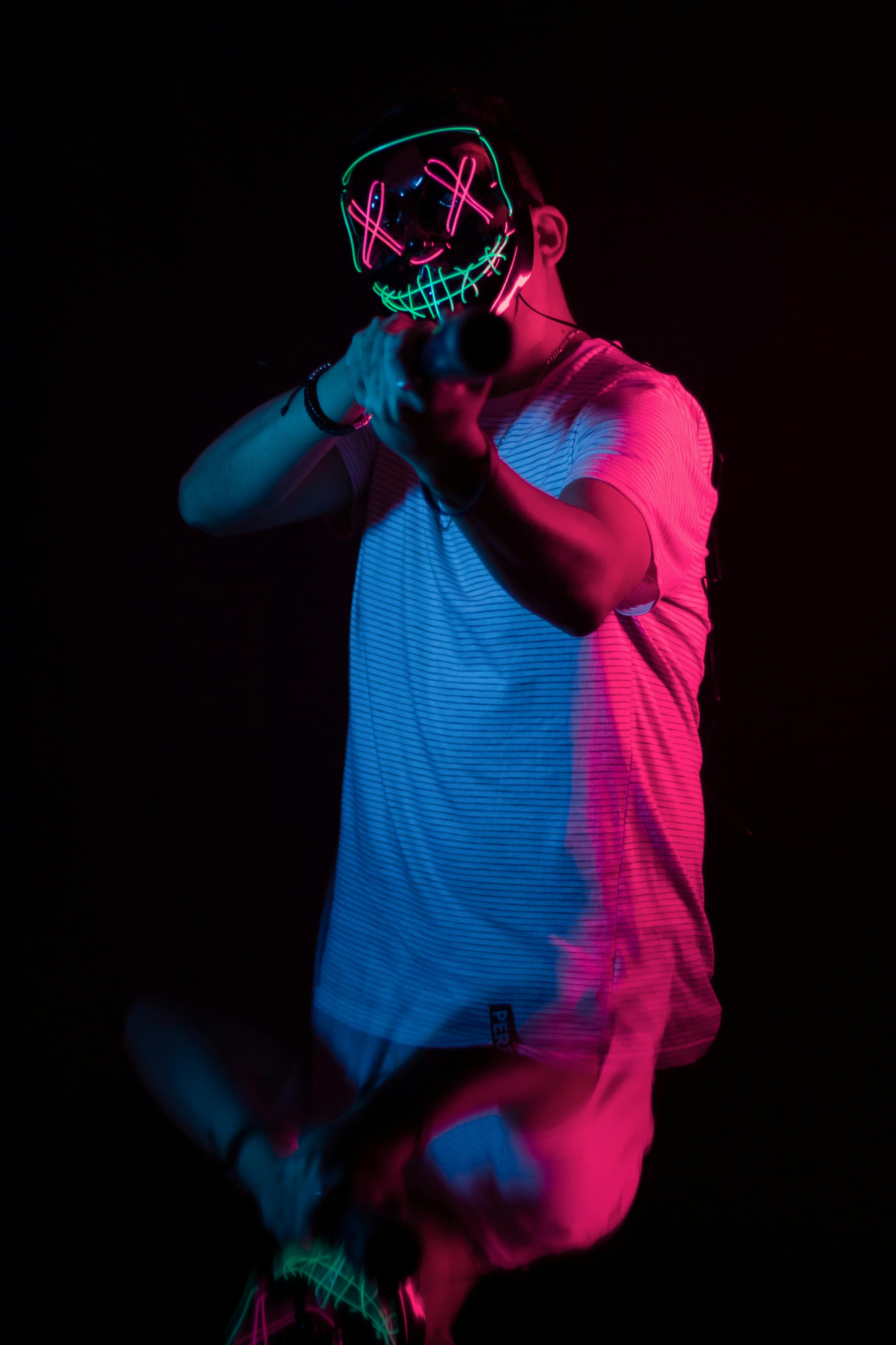 Person Wearing LED Mask Doing Silence Gesture · Free Stock Photo