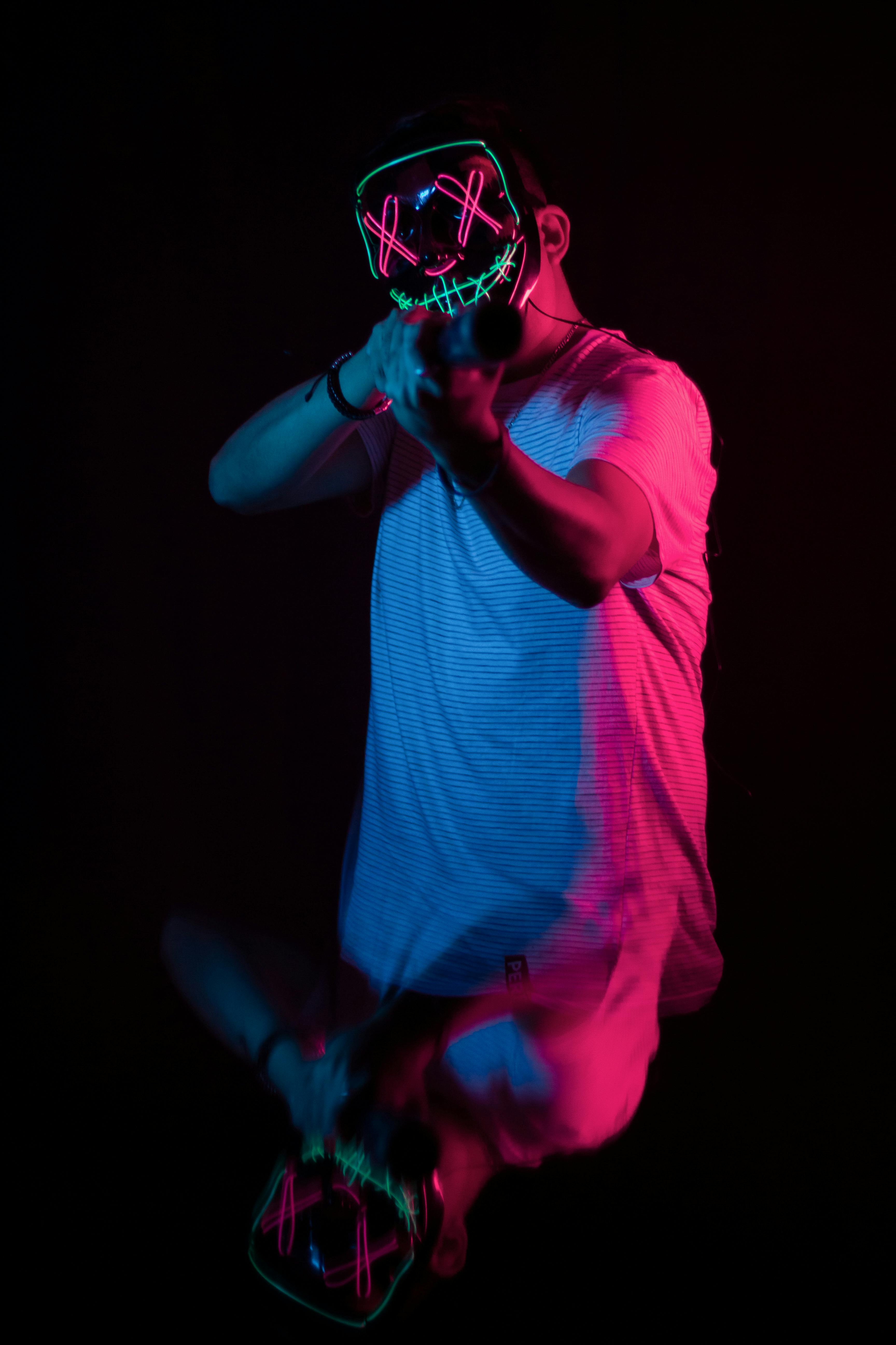 A Man Wearing an LED Halloween Mask and Holding a Baseball Bat · Free ...
