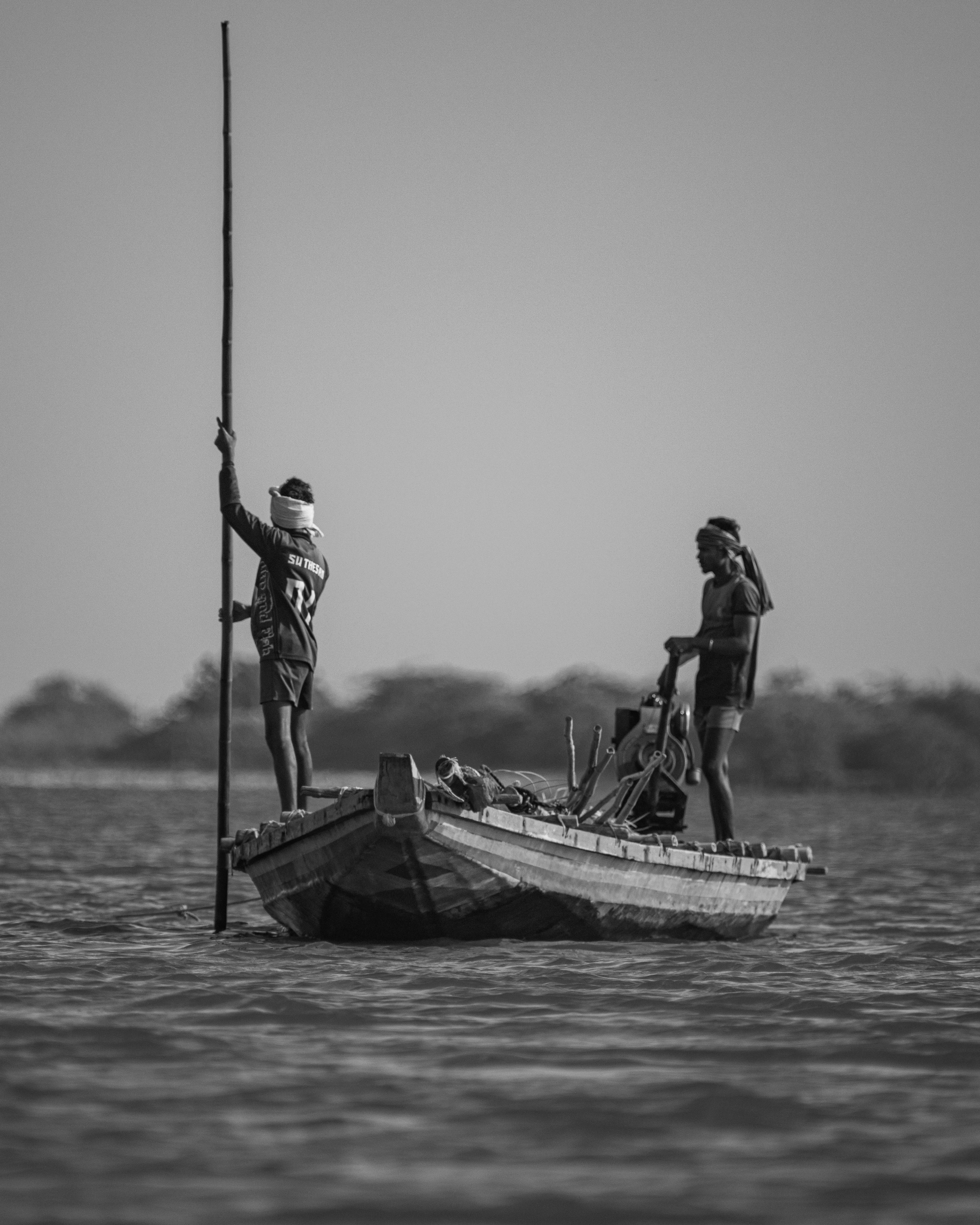 Men Rowing a Wooden Boat · Free Stock Photo