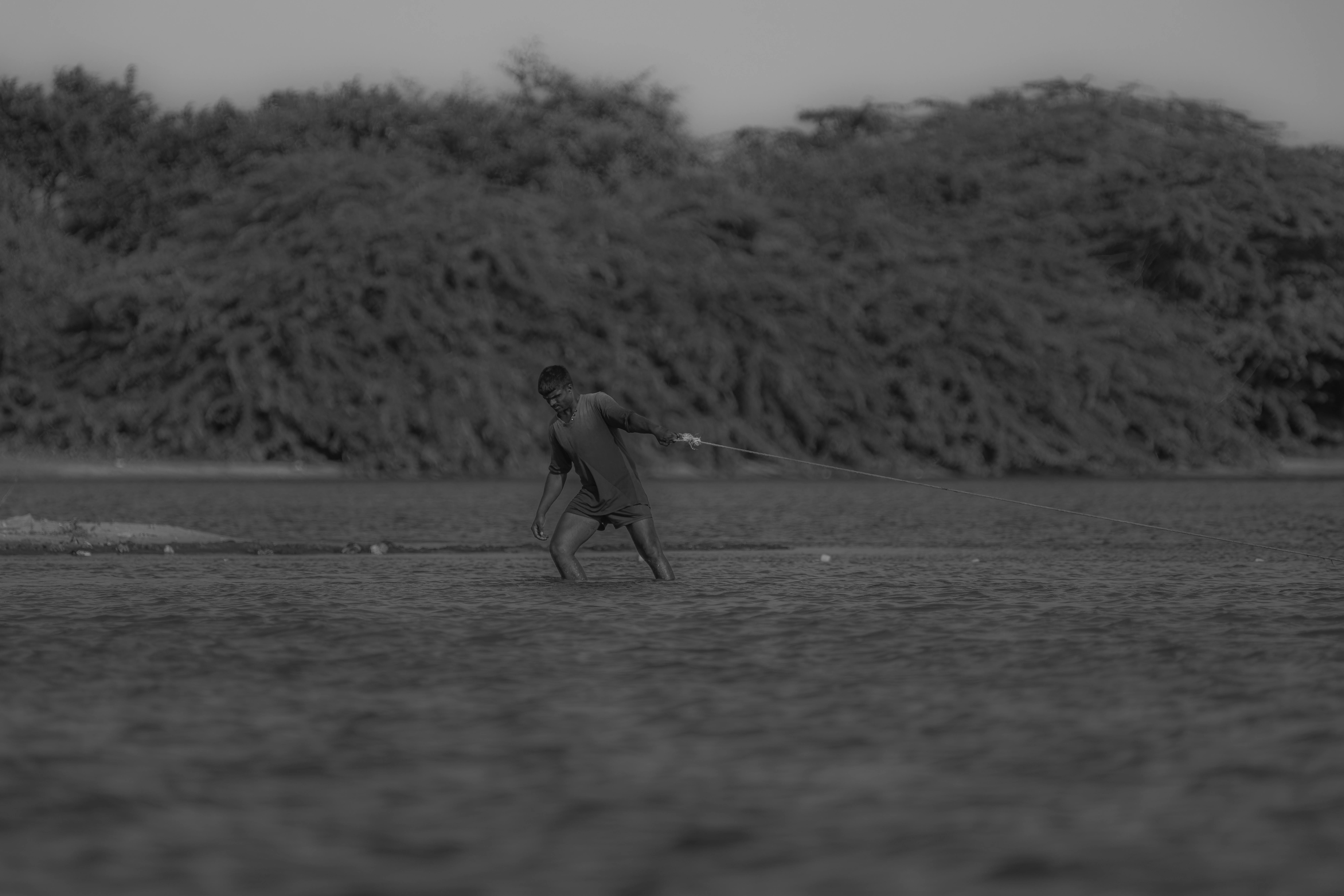 Man Pulling Rope in River · Free Stock Photo