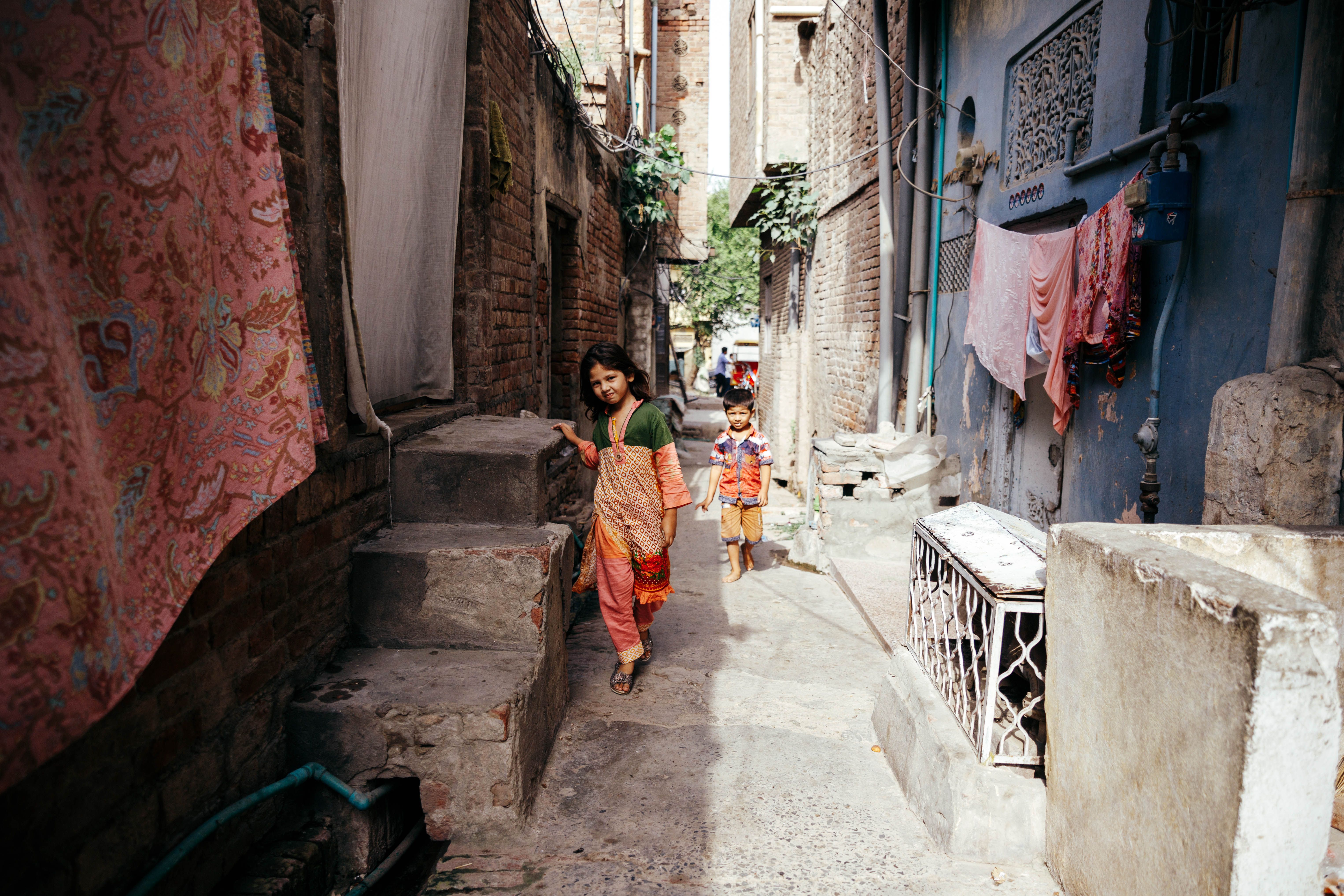 Two Kids Walking on Alley · Free Stock Photo