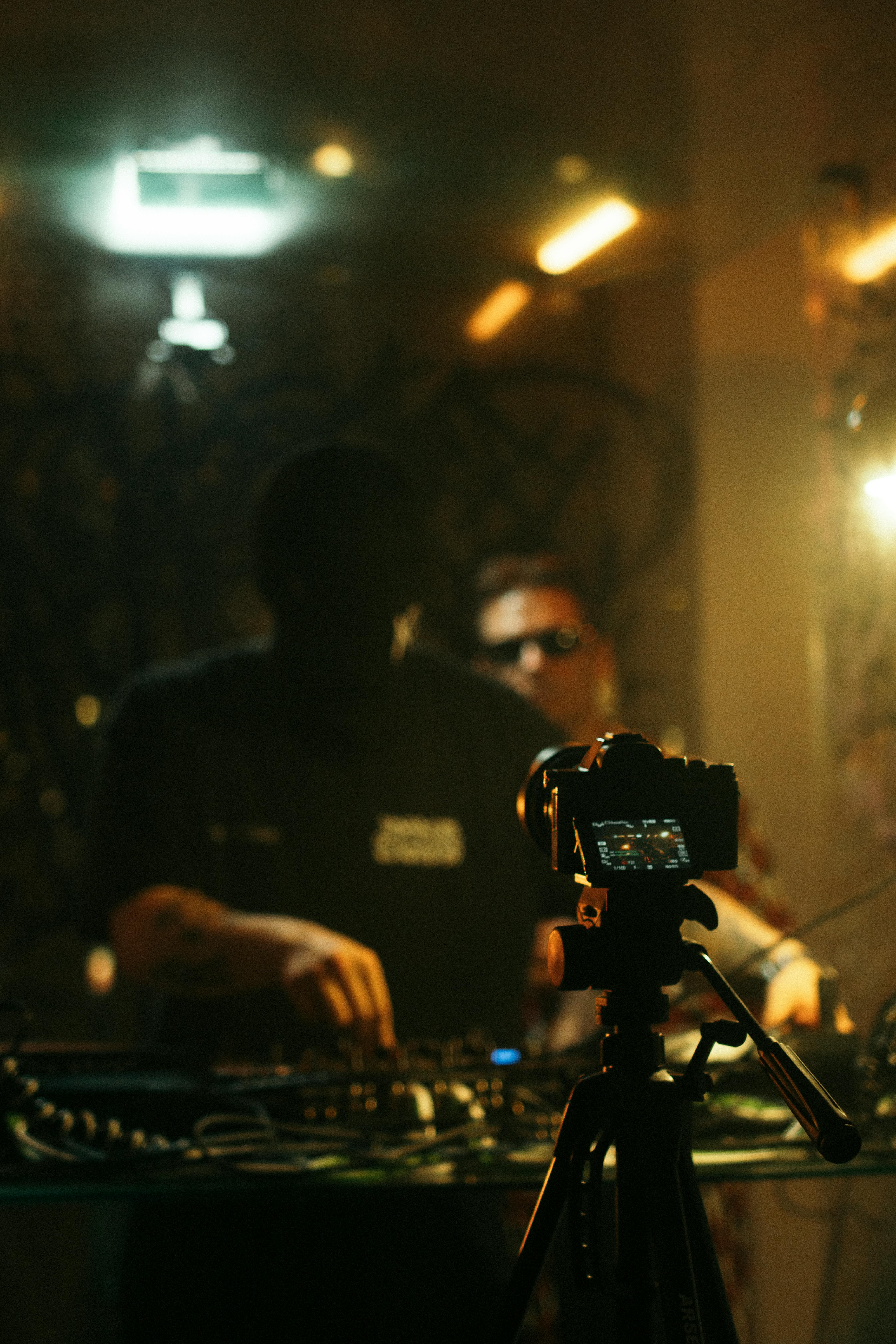Camera on Tripod Filming DJ on Set · Free Stock Photo