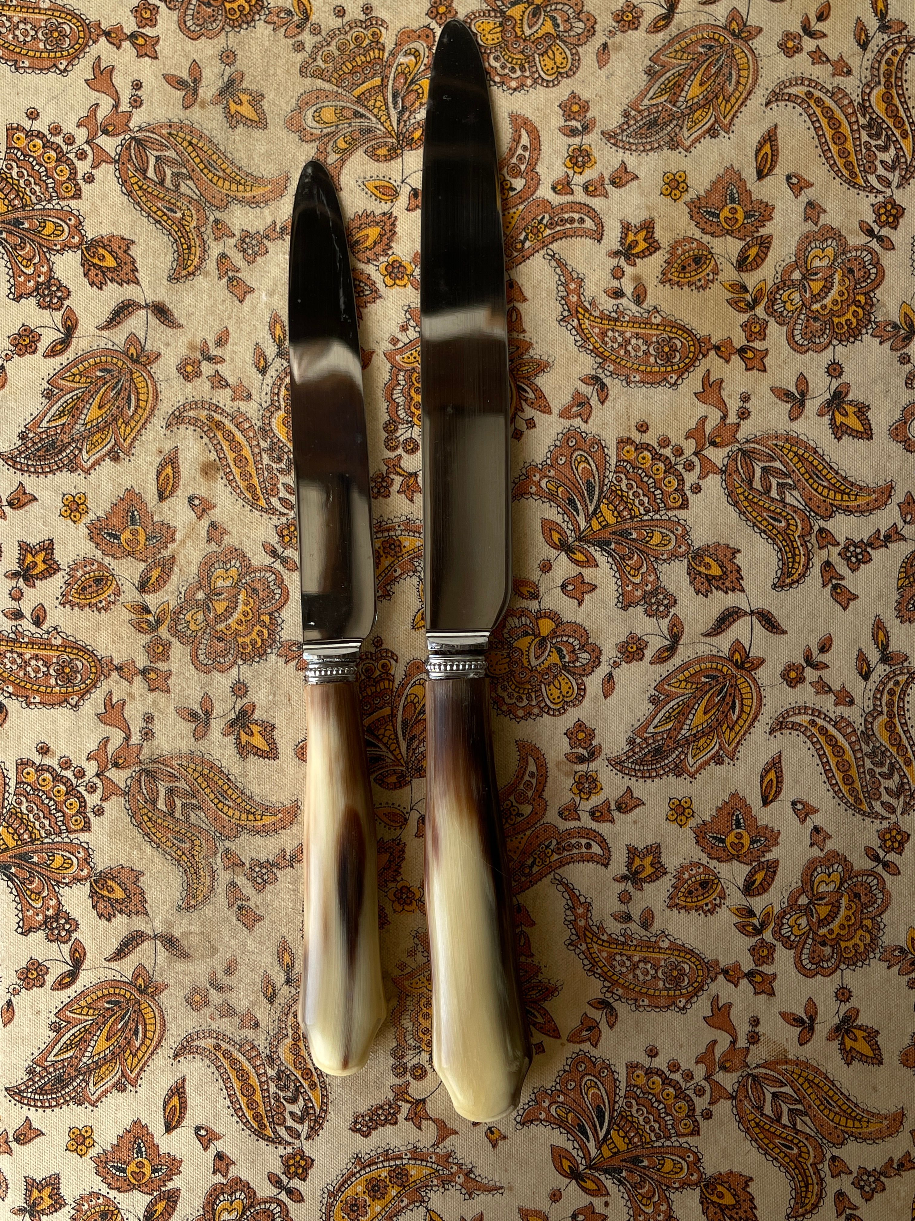 Two Vintage Knives Lying on a Patterned Cloth · Free Stock Photo