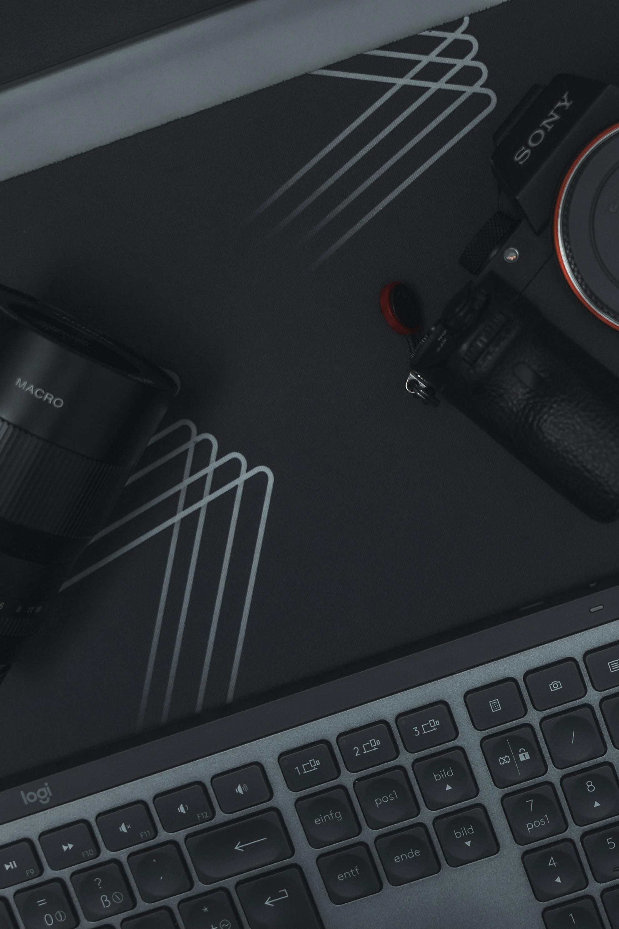 Digital Camera and Lens Next to Wireless Keyboard on Black Desk · Free ...