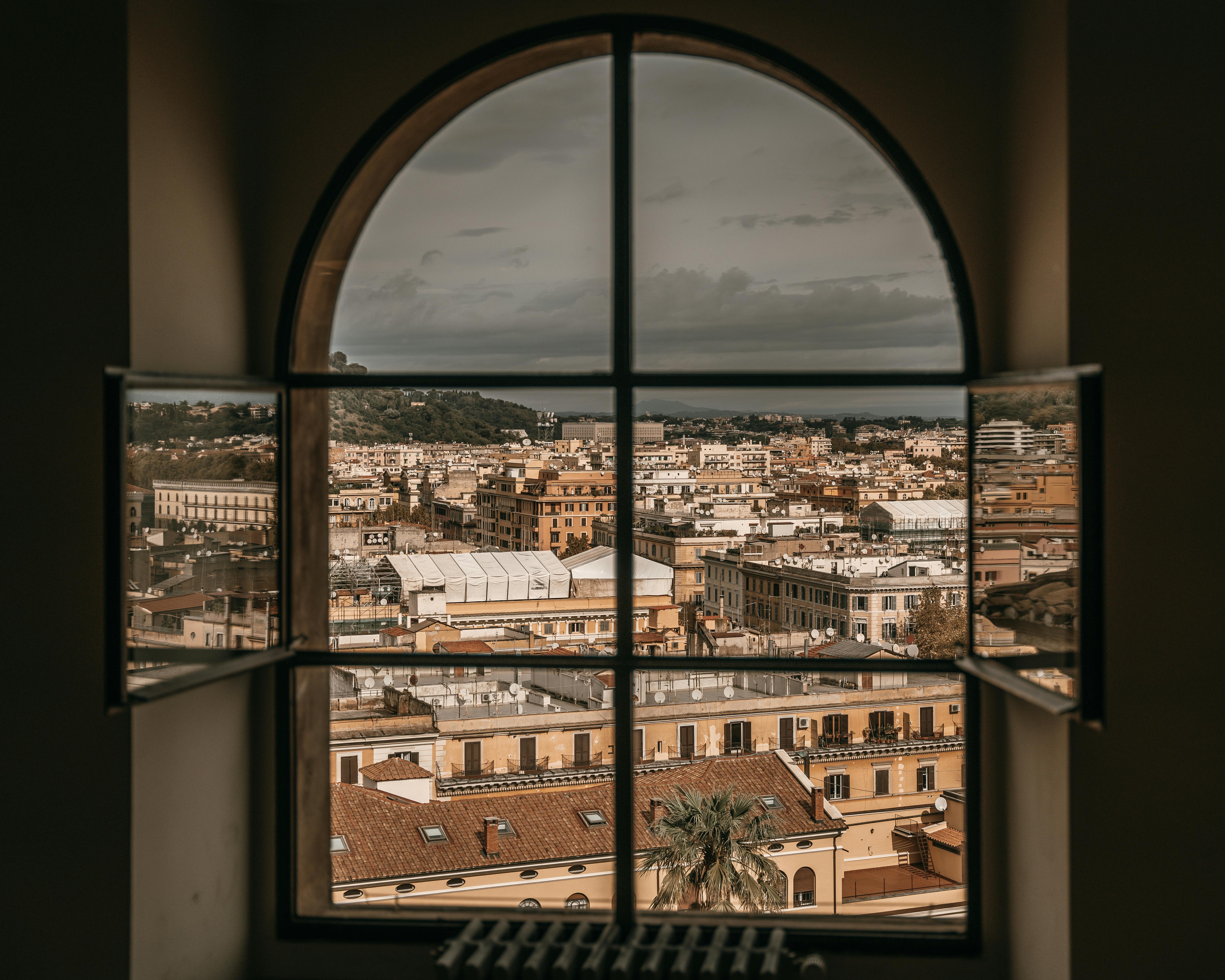 City Buildings behind Windows · Free Stock Photo