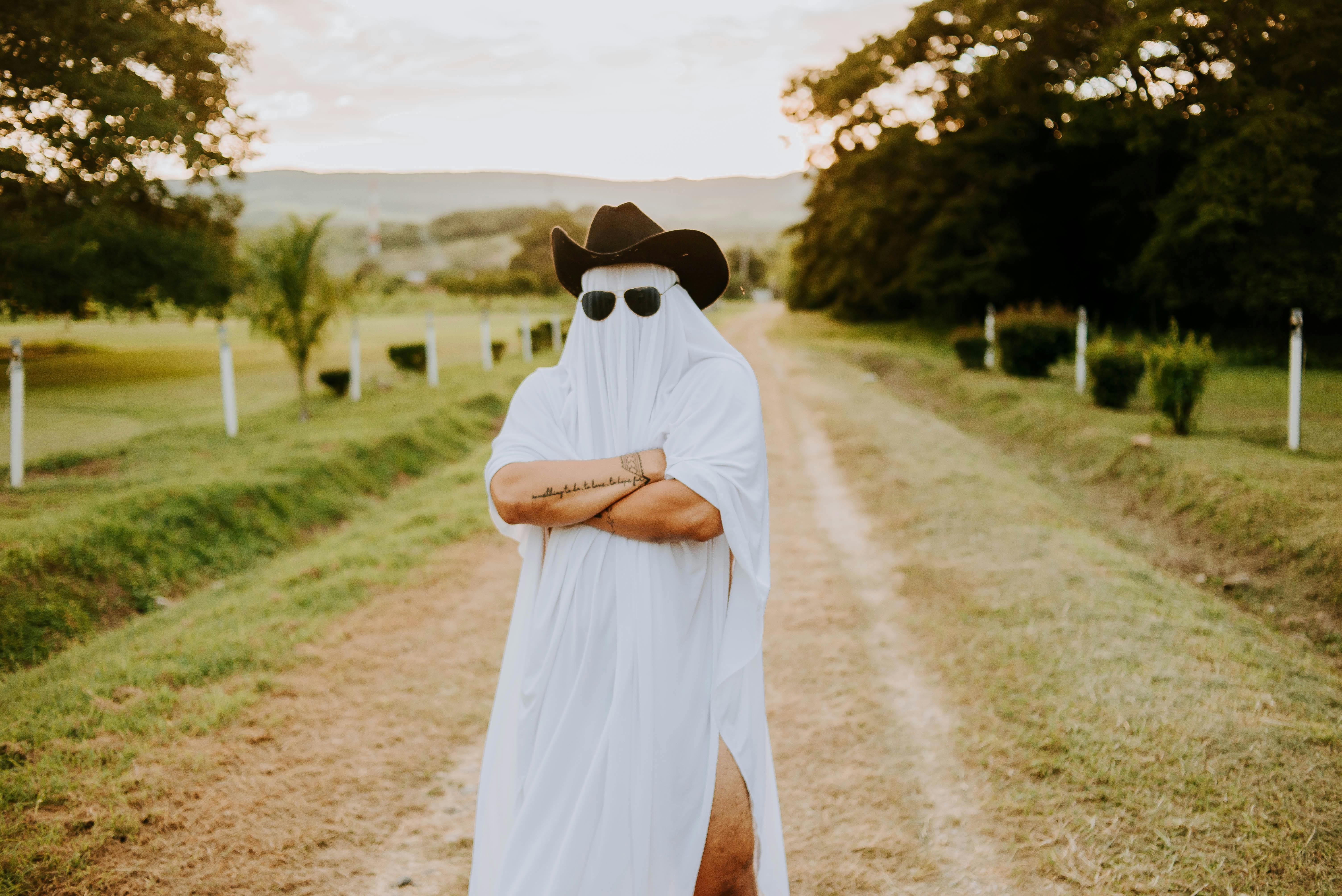 Ghost Standing with Arms Crossed on Dirt Road · Free Stock Photo