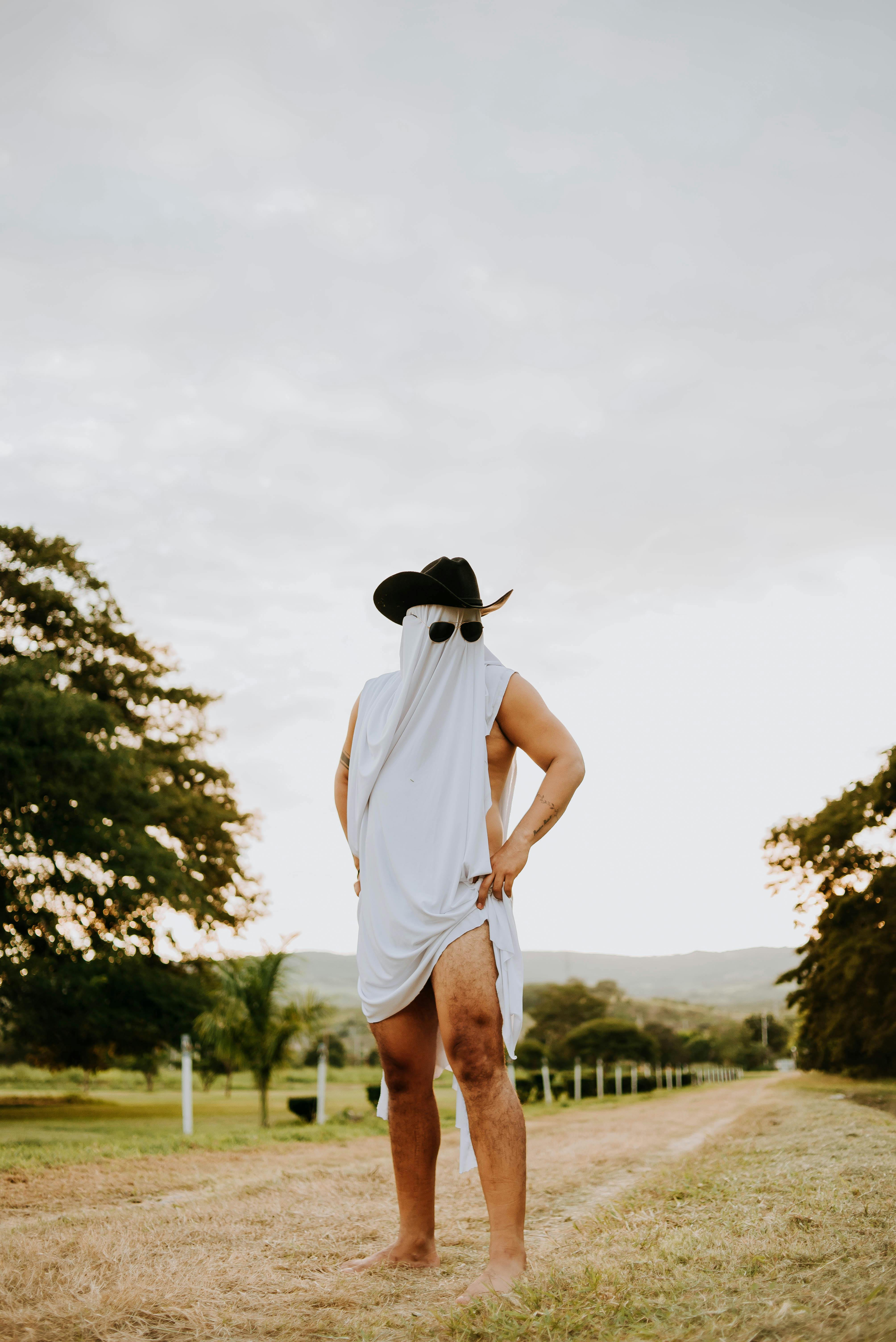 Man in Ghost Costume with Sunglasses and Hat · Free Stock Photo
