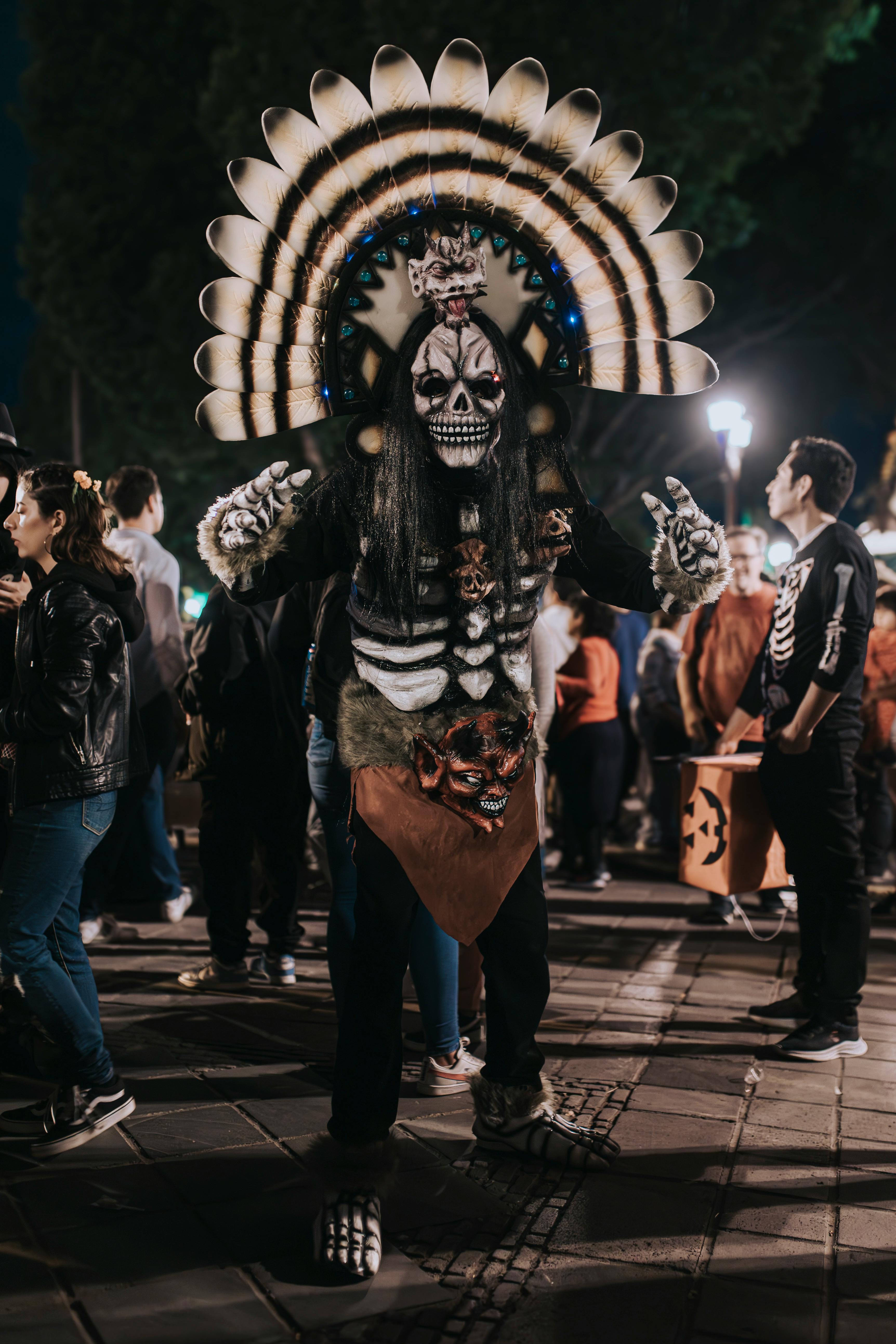 Person in Skeleton Costume with Crown in Crowd at Night · Free Stock Photo