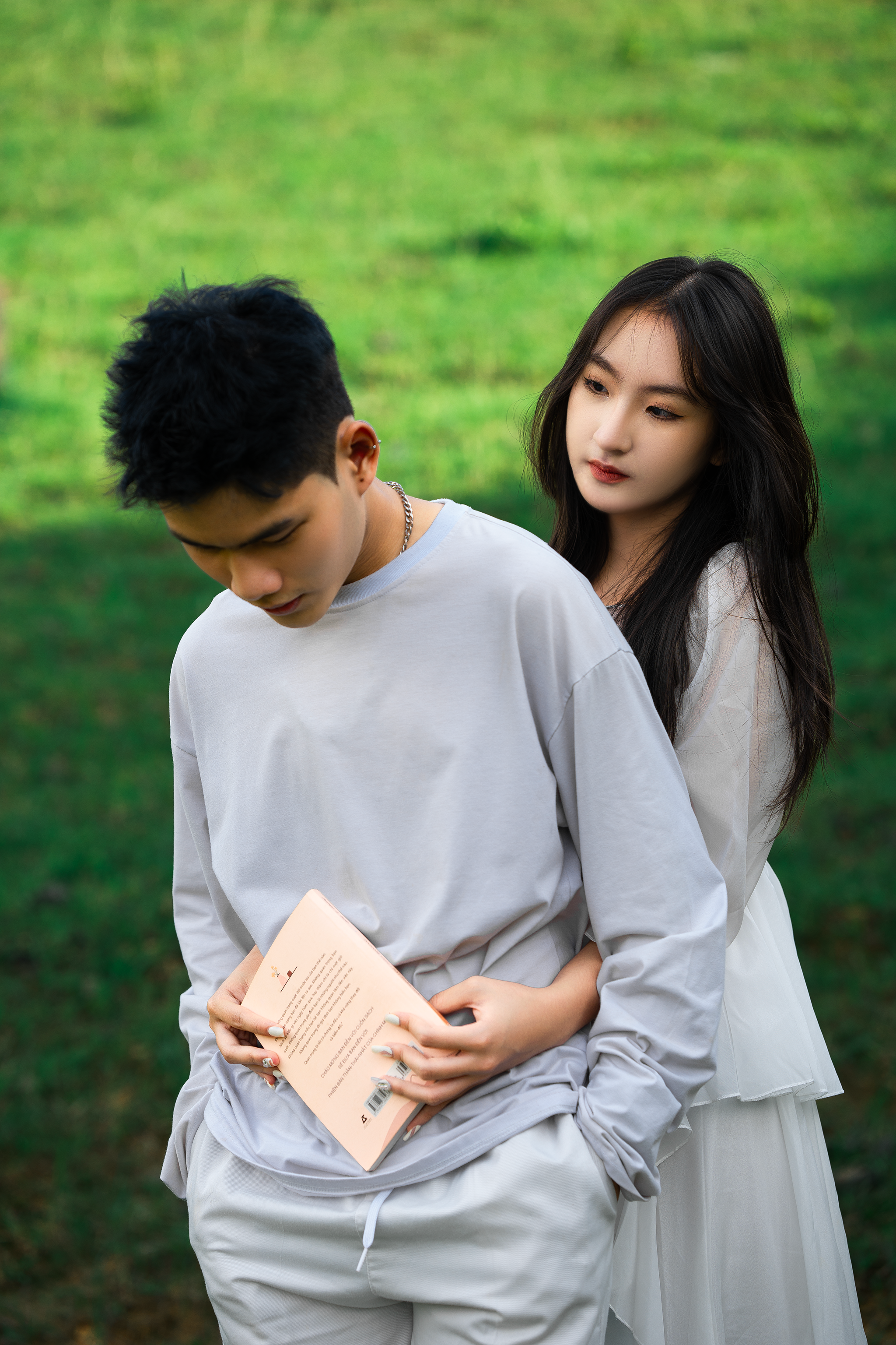 Woman Embracing Man Holding Book · Free Stock Photo