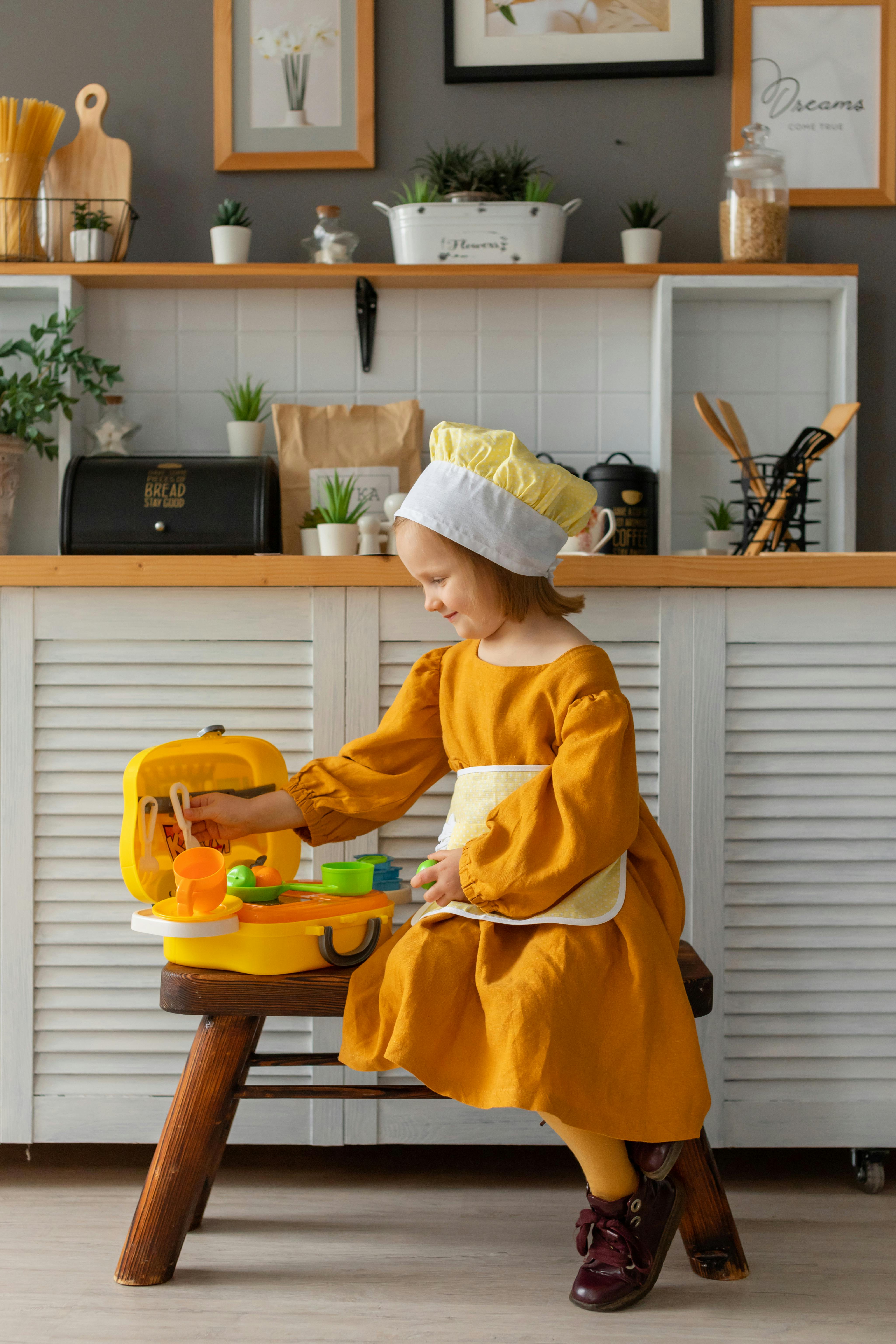 A Girl Playing in a Kitchen · Free Stock Photo