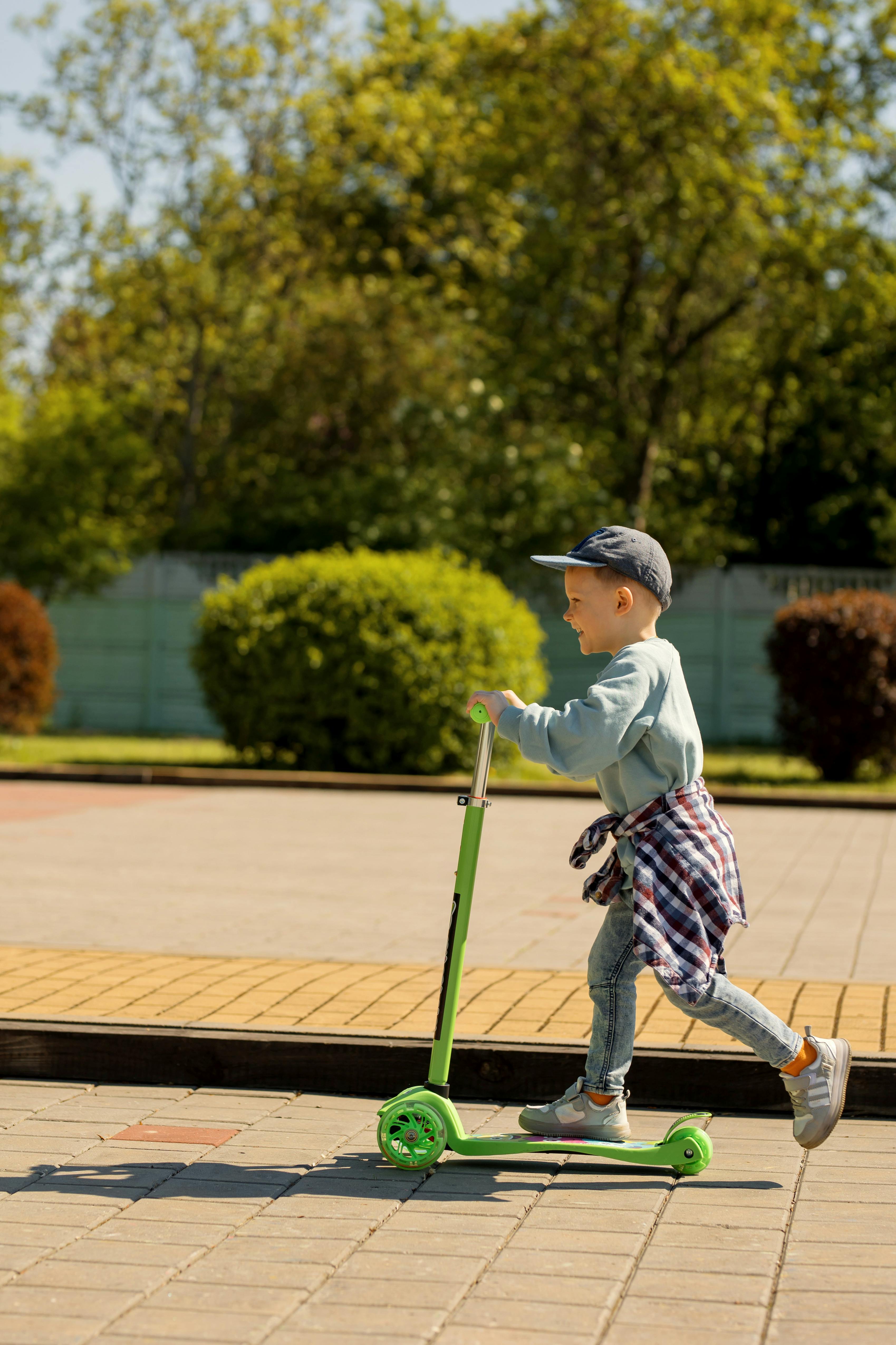 Boy Riding Scooter at Park · Free Stock Photo