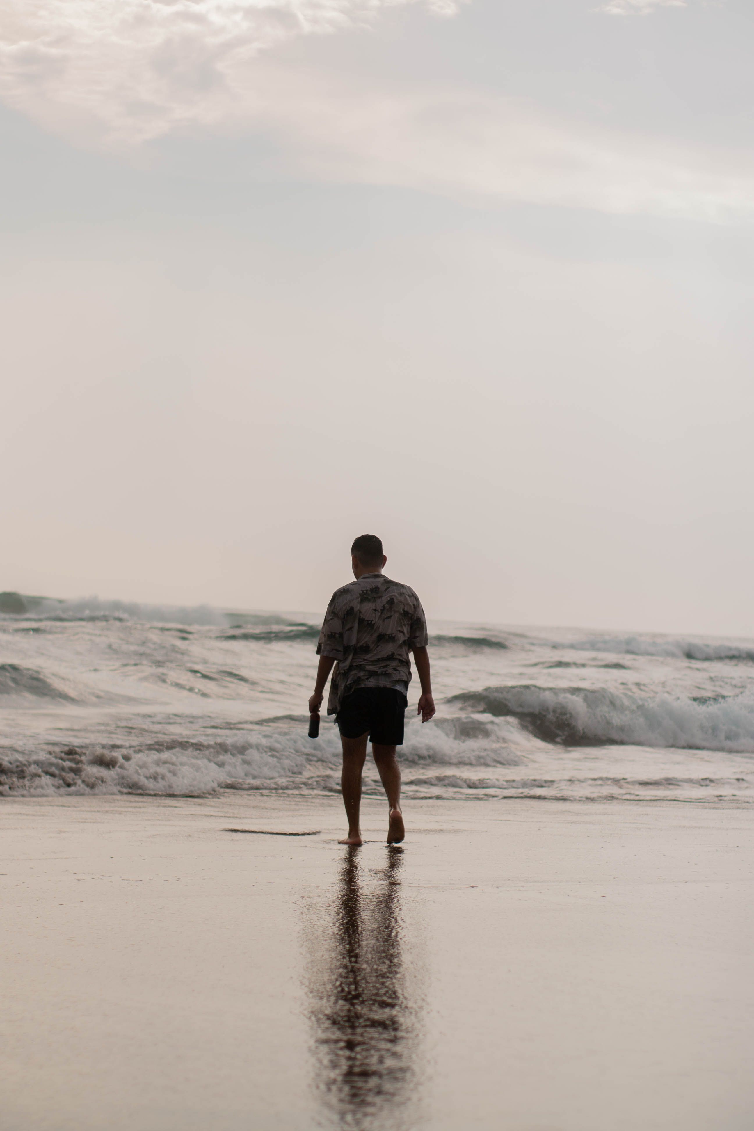 Man Walking on Wet Sand · Free Stock Photo