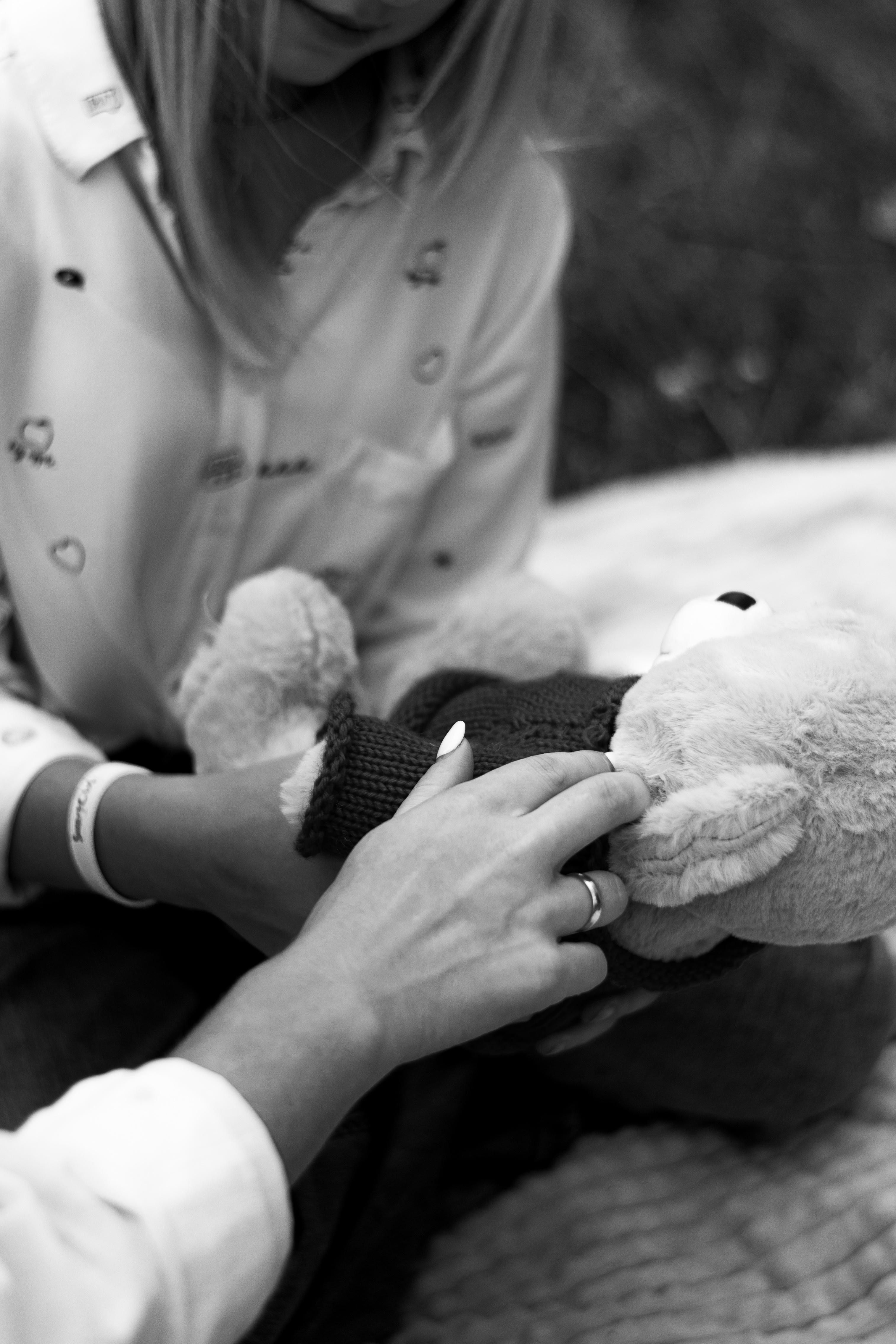 Black and White Photo of a Woman and a Girl Touching a Teddy Bear ...