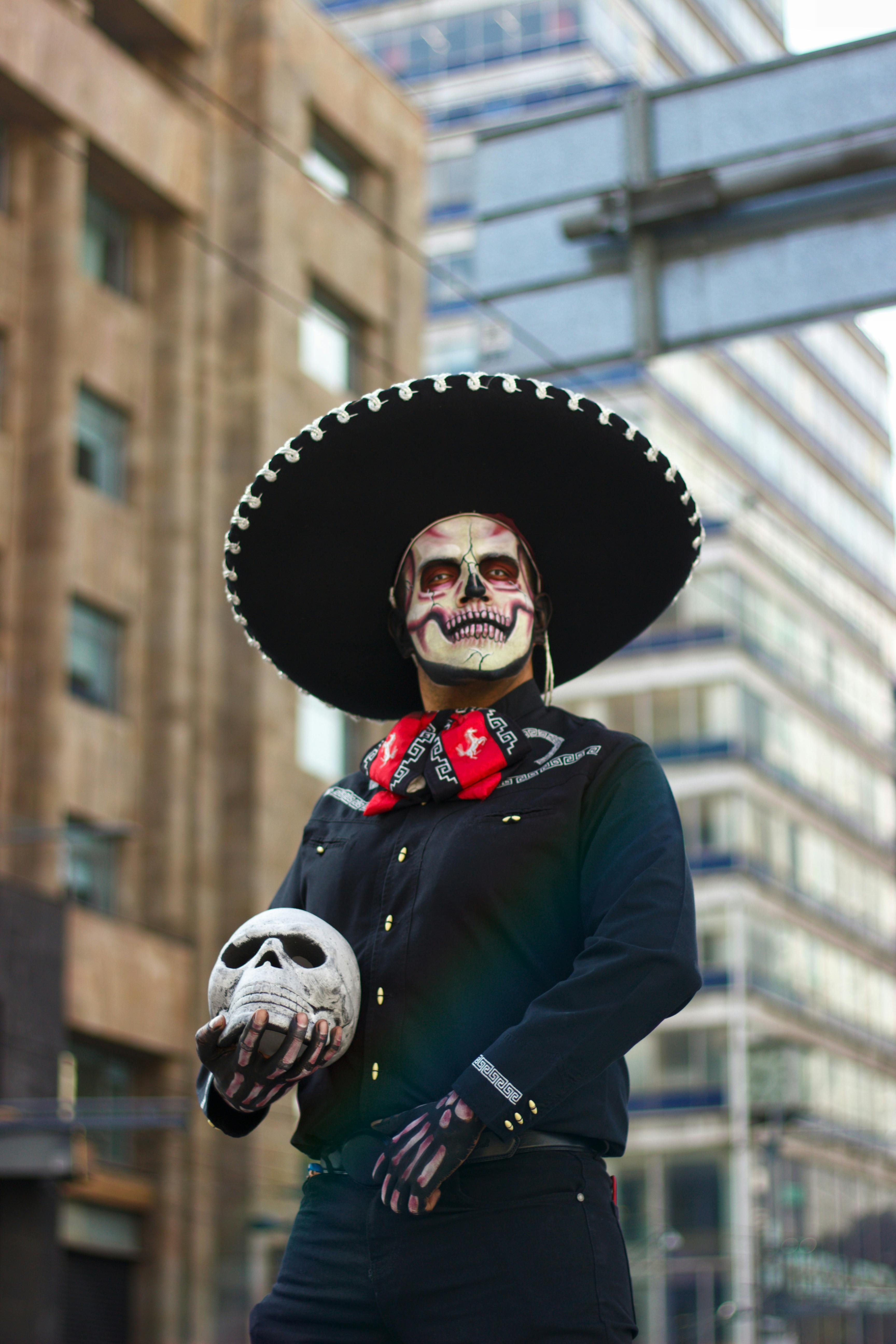 Catrin Holding a Skull by the City Street on the Day of the Dead · Free ...