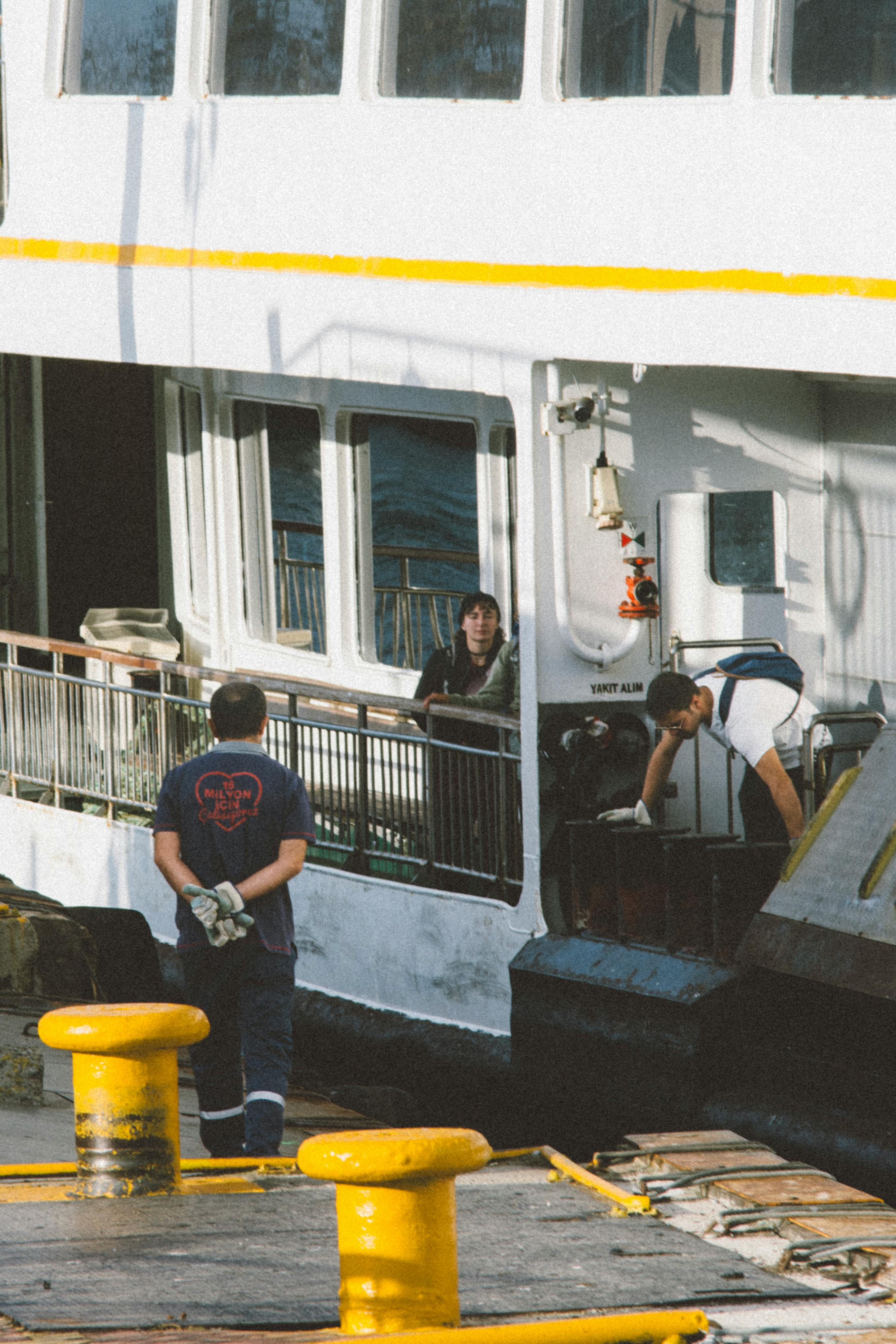 Ferry and Harbor Workers After Unmooring the Ship · Free Stock Photo