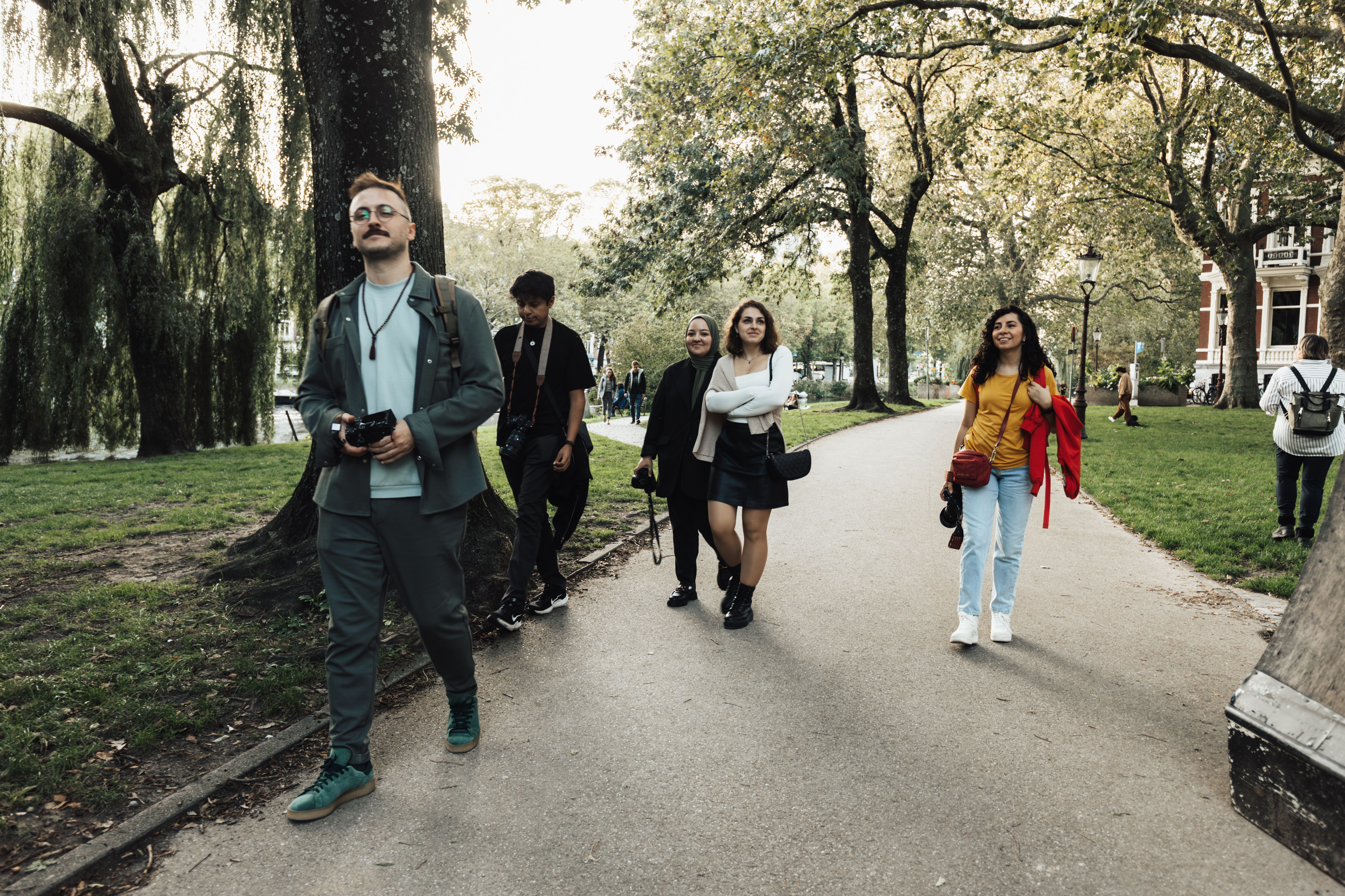 Group of Photographers Walking in the Park Looking for the Perfect Shot ...
