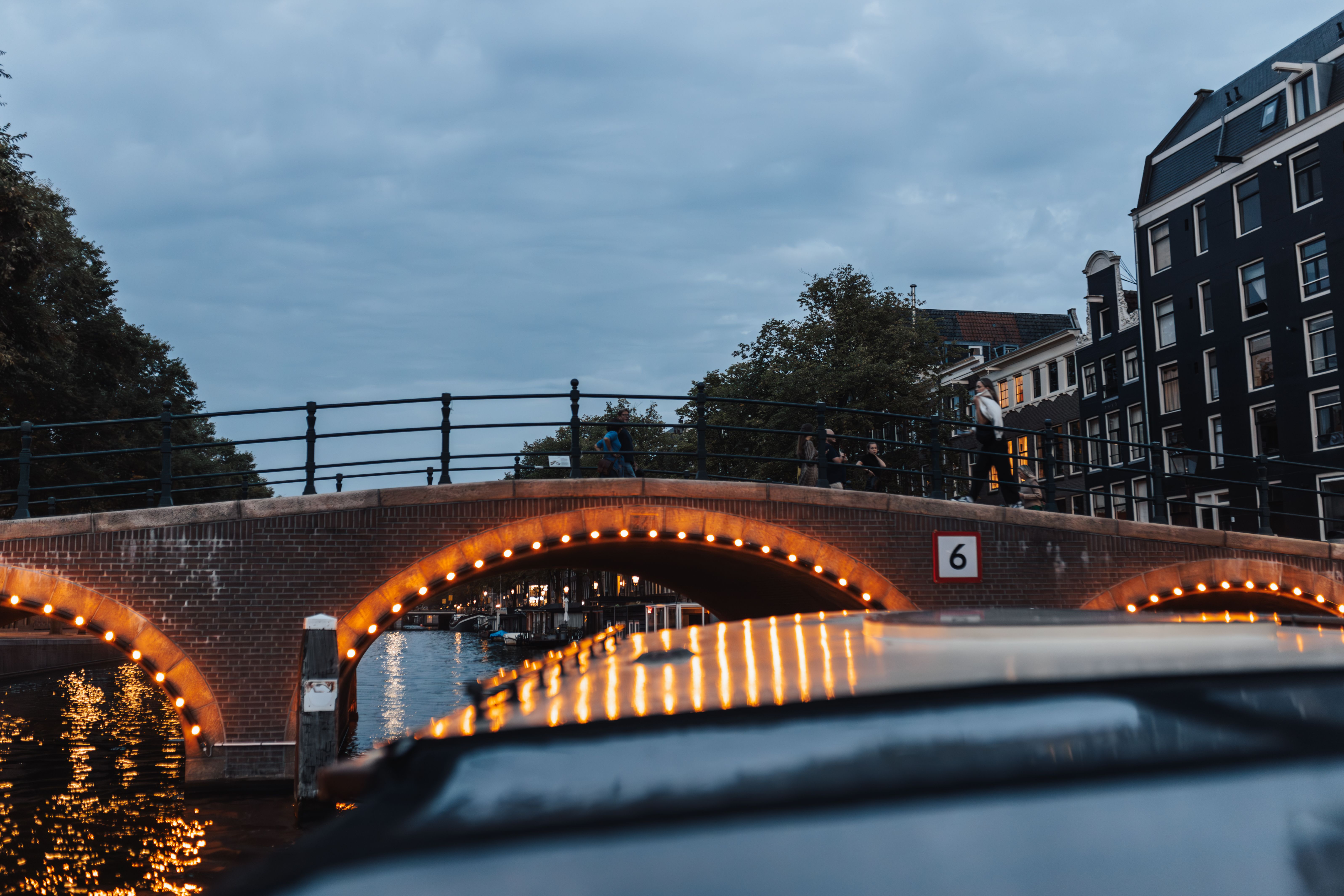 Bridge behind Boat on Canal in Town · Free Stock Photo