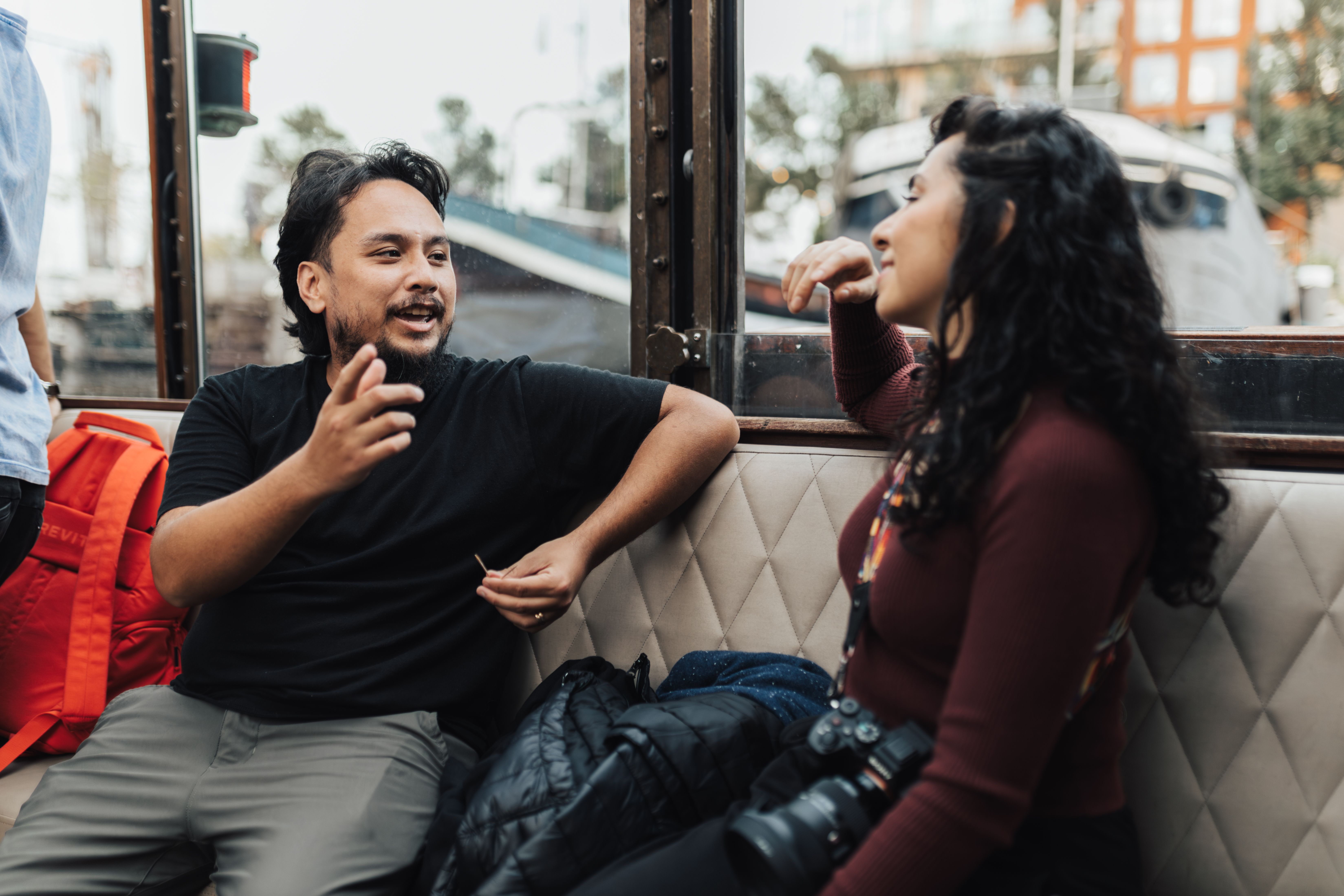 Man and Woman Sitting by the Window and Talking · Free Stock Photo