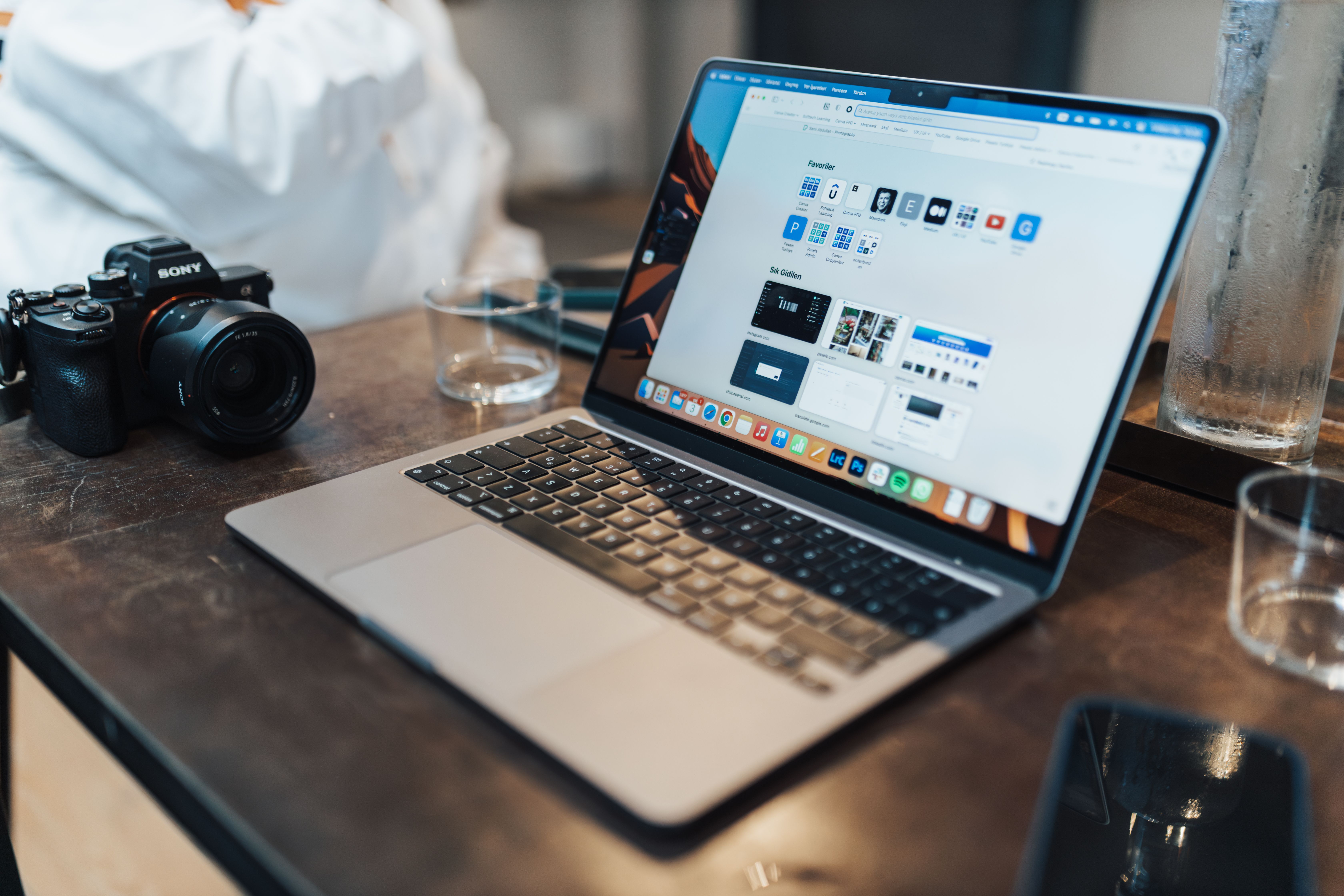 MacBook and Camera on Table · Free Stock Photo