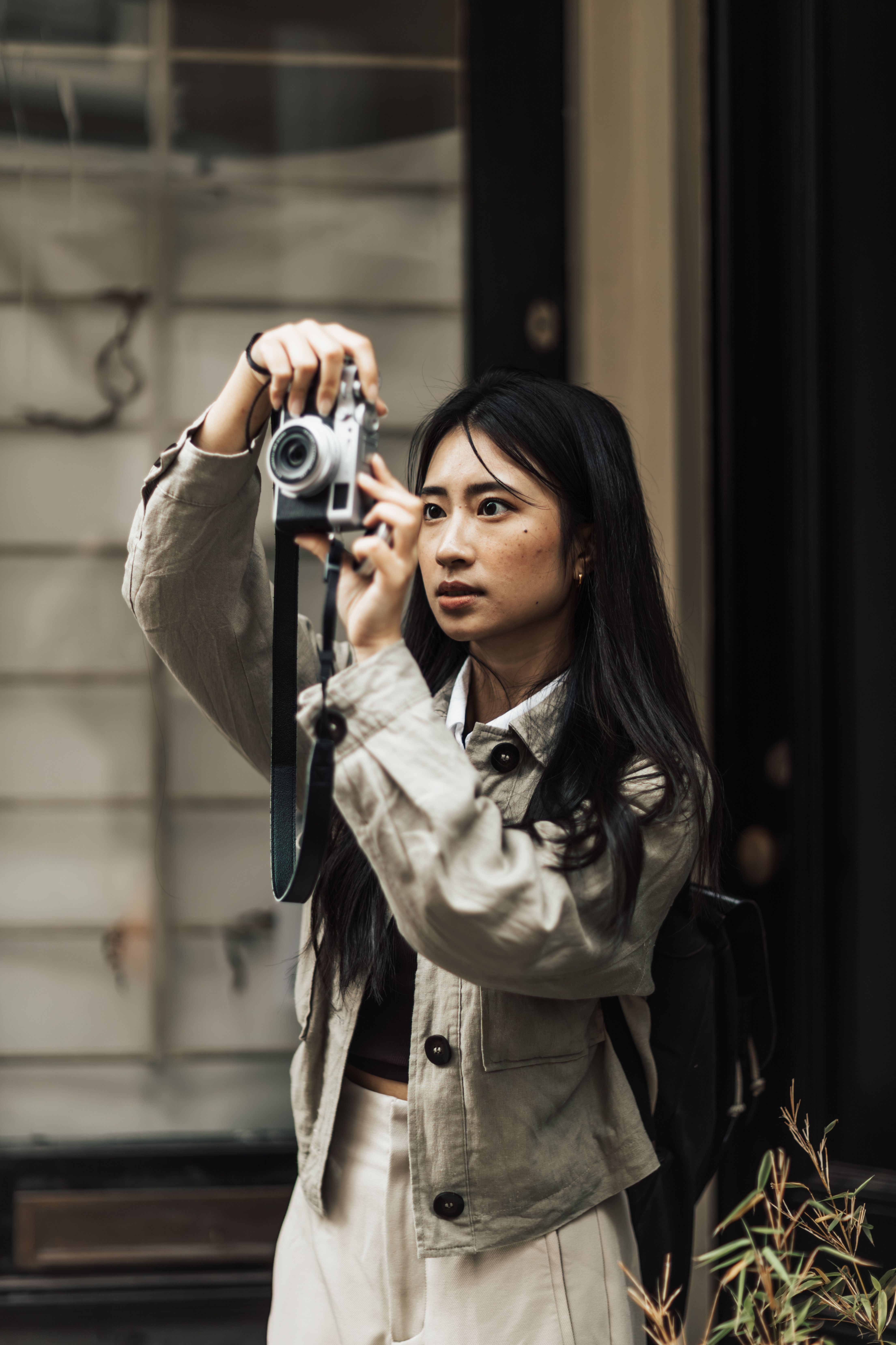 Woman with Long Black Hair Holding a Camera · Free Stock Photo