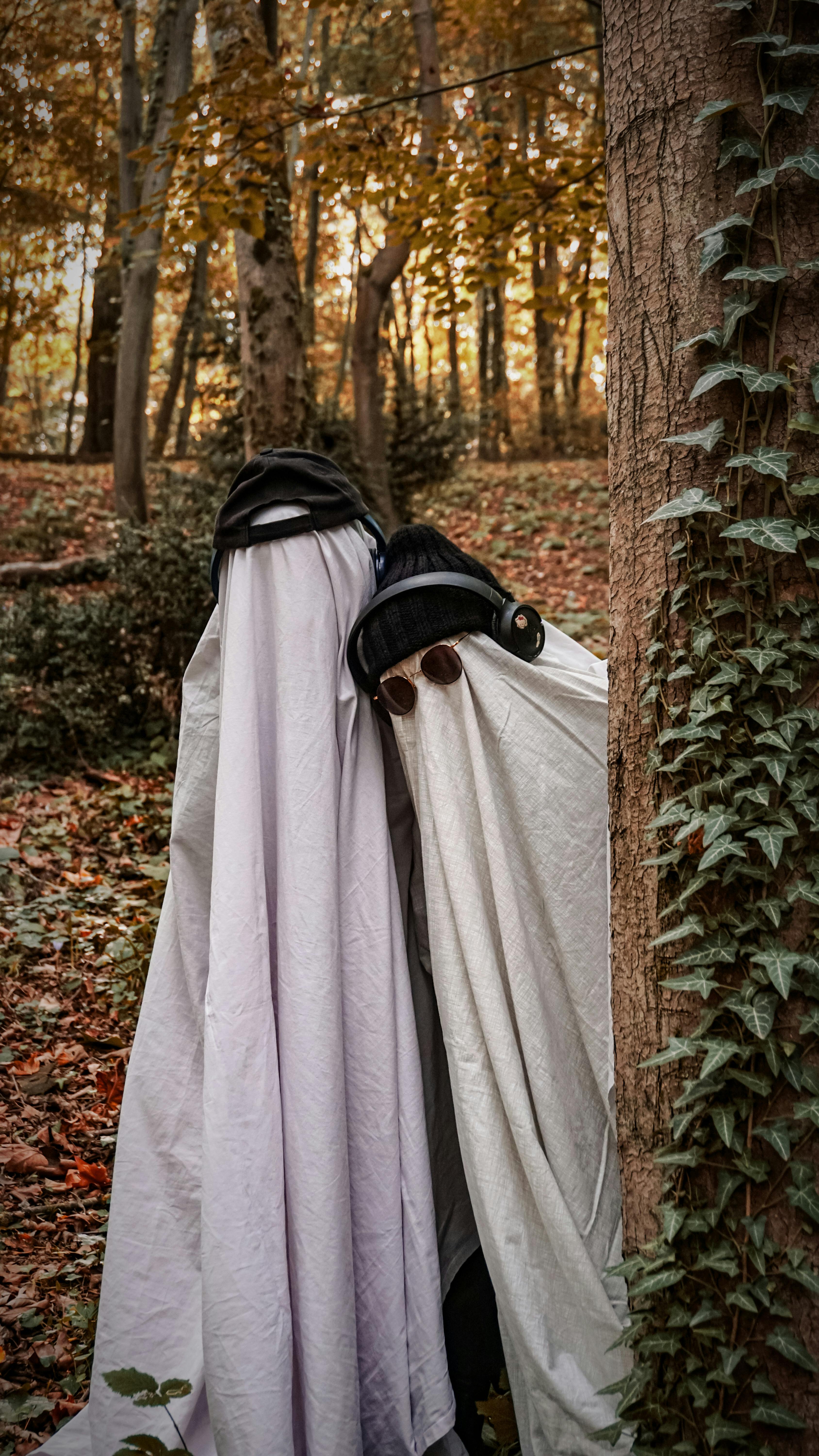 People in Ghost Costumes Walking in Wood · Free Stock Photo