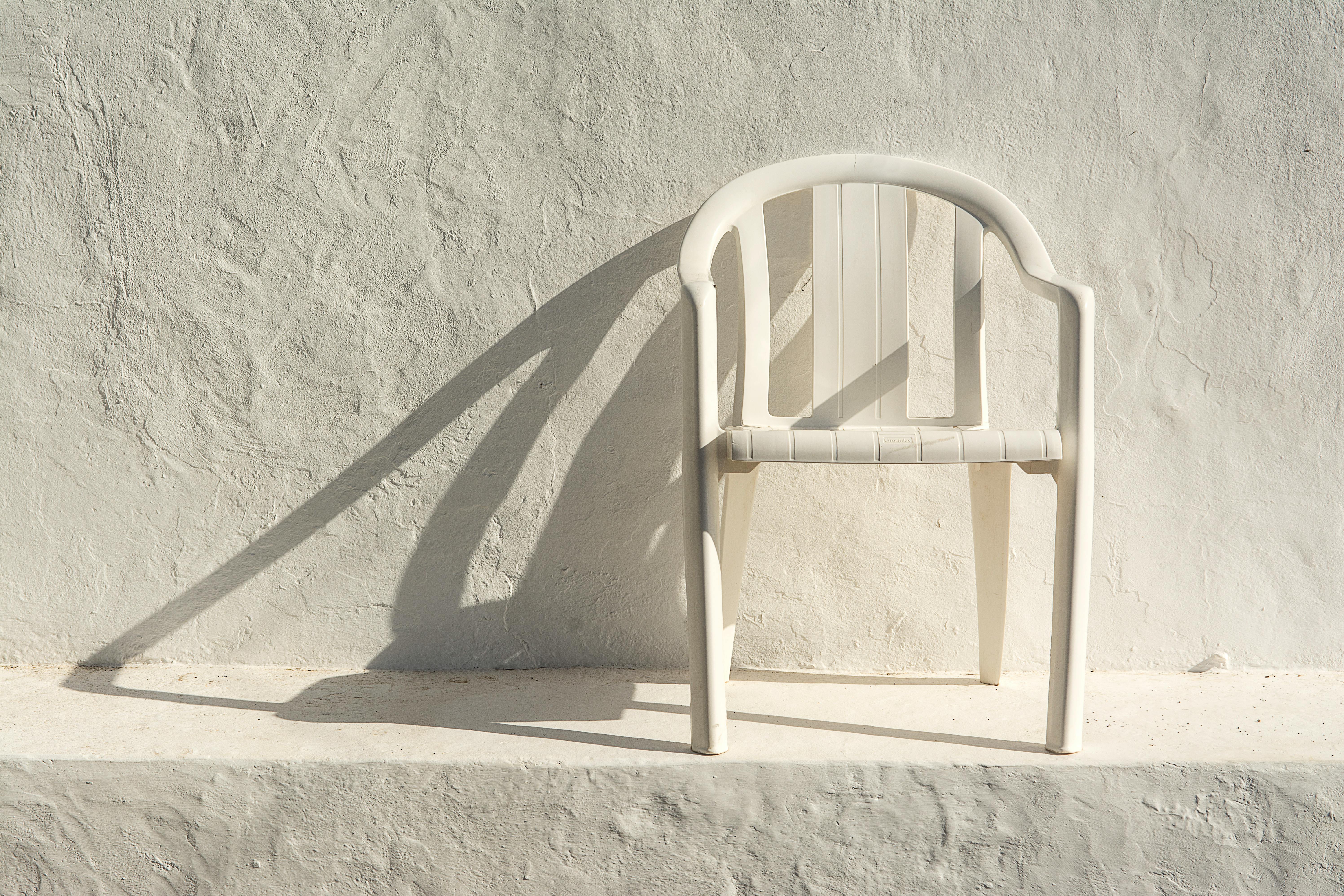 Plastic Chair Casting Shadow · Free Stock Photo