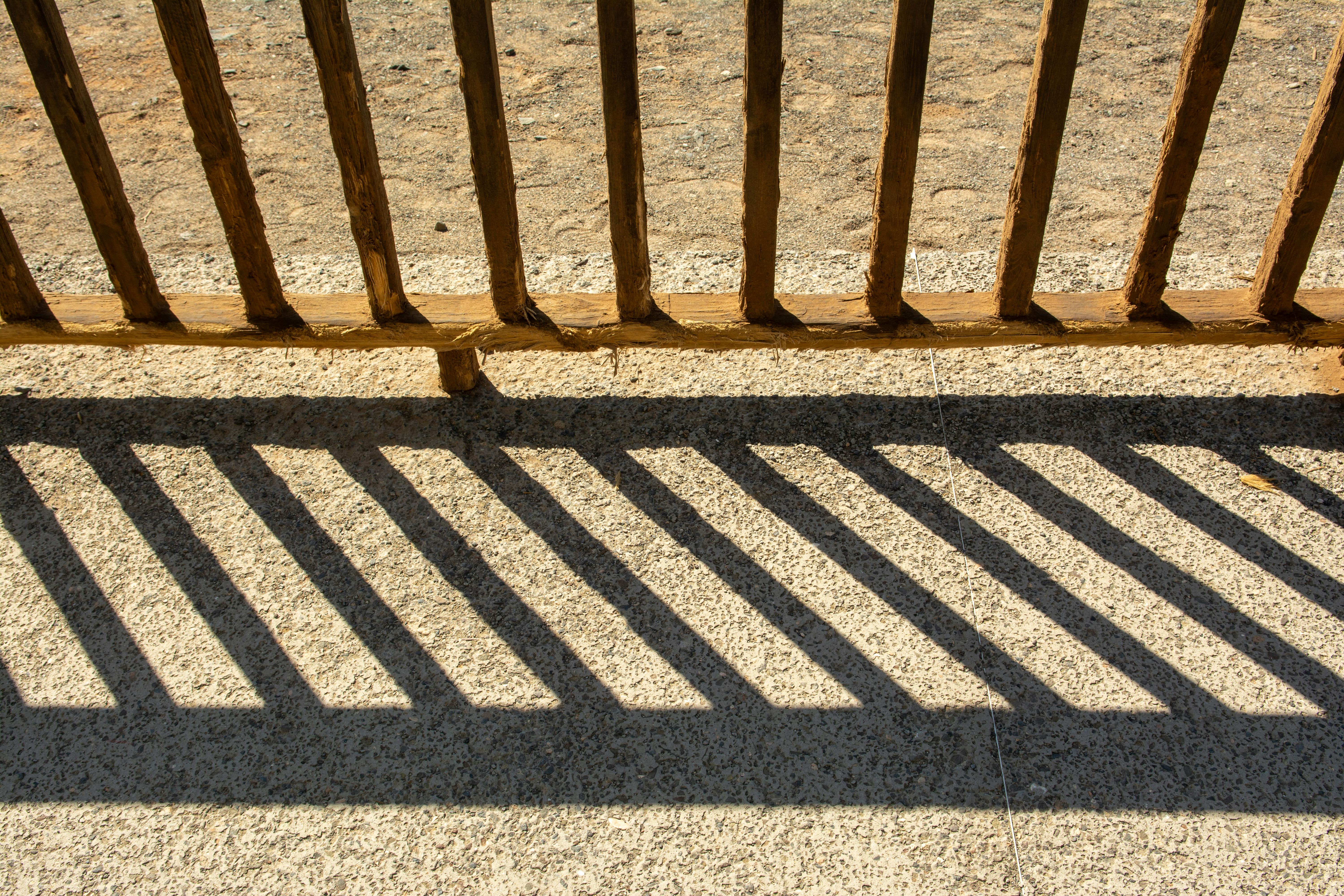 Chipped Wooden Railing Casting a Shadow on the Granite Terrace · Free ...