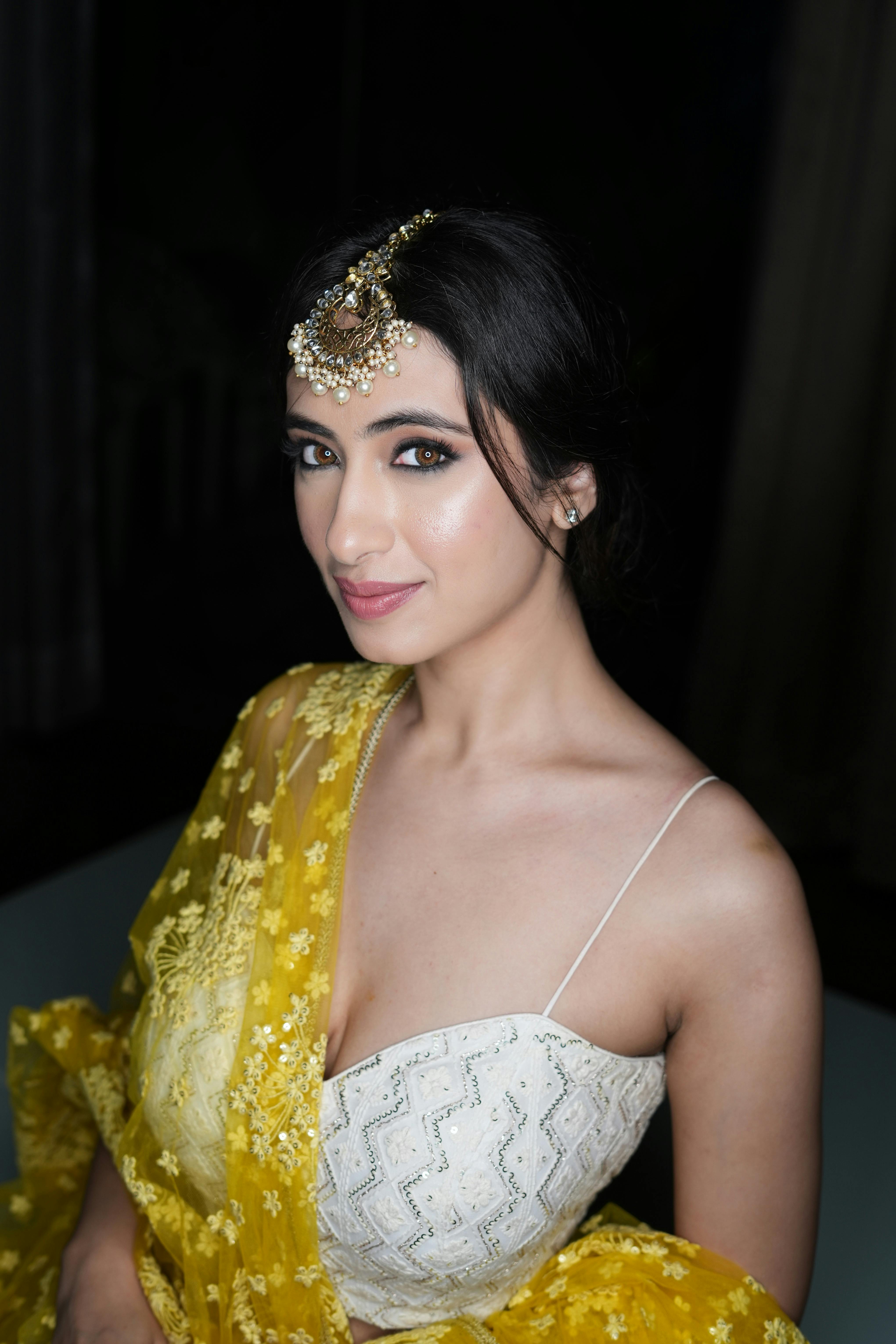 Smiling Woman in Yellow Sari Wearing Ornate Headpiece · Free Stock Photo