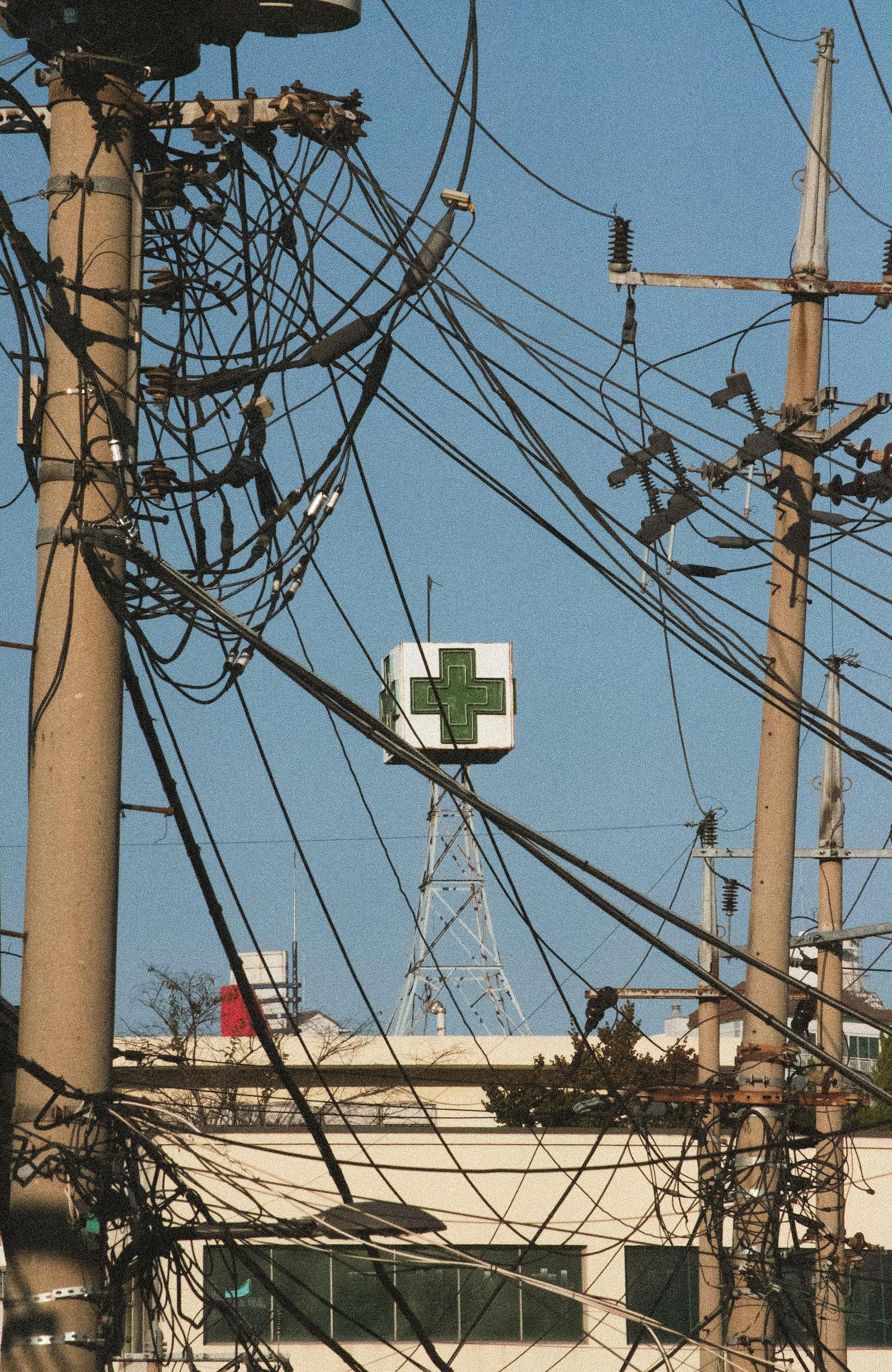 Electricity Wires and Posts in Front of Green Cross on Tower in Seoul ...