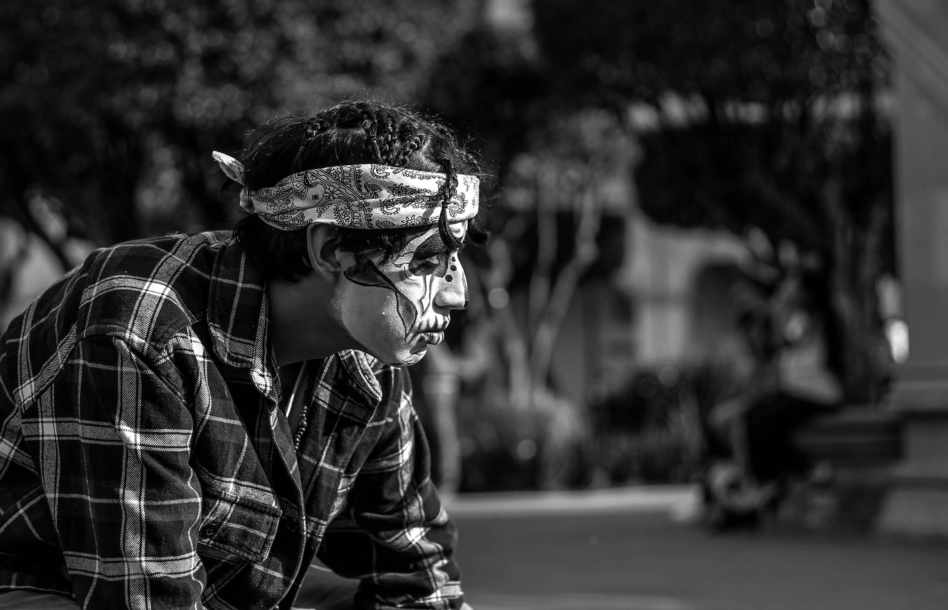 Black and White Image of Person Wearing Skull Make-Up Staring Into ...