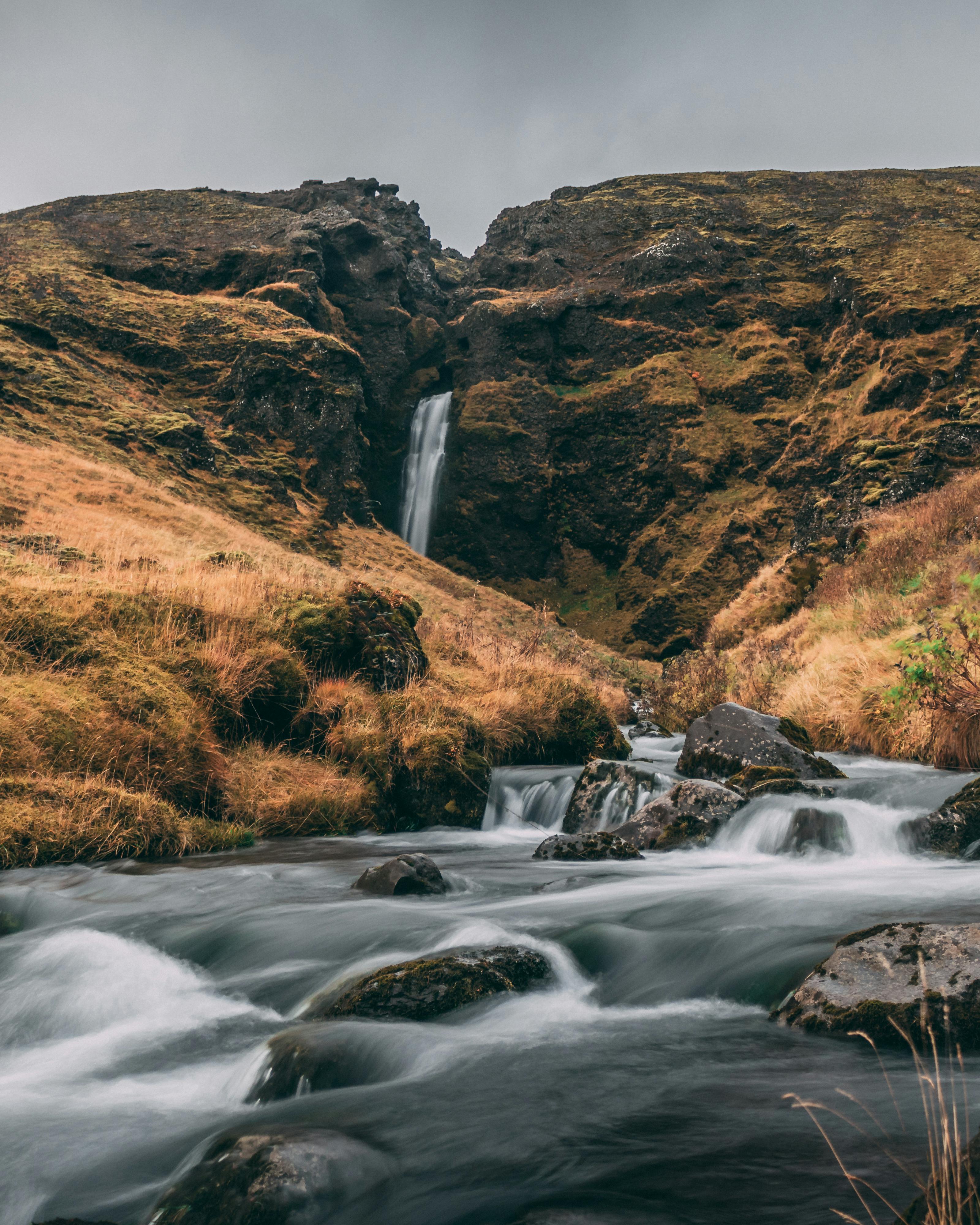 Waterfall in Between Rock Formations · Free Stock Photo