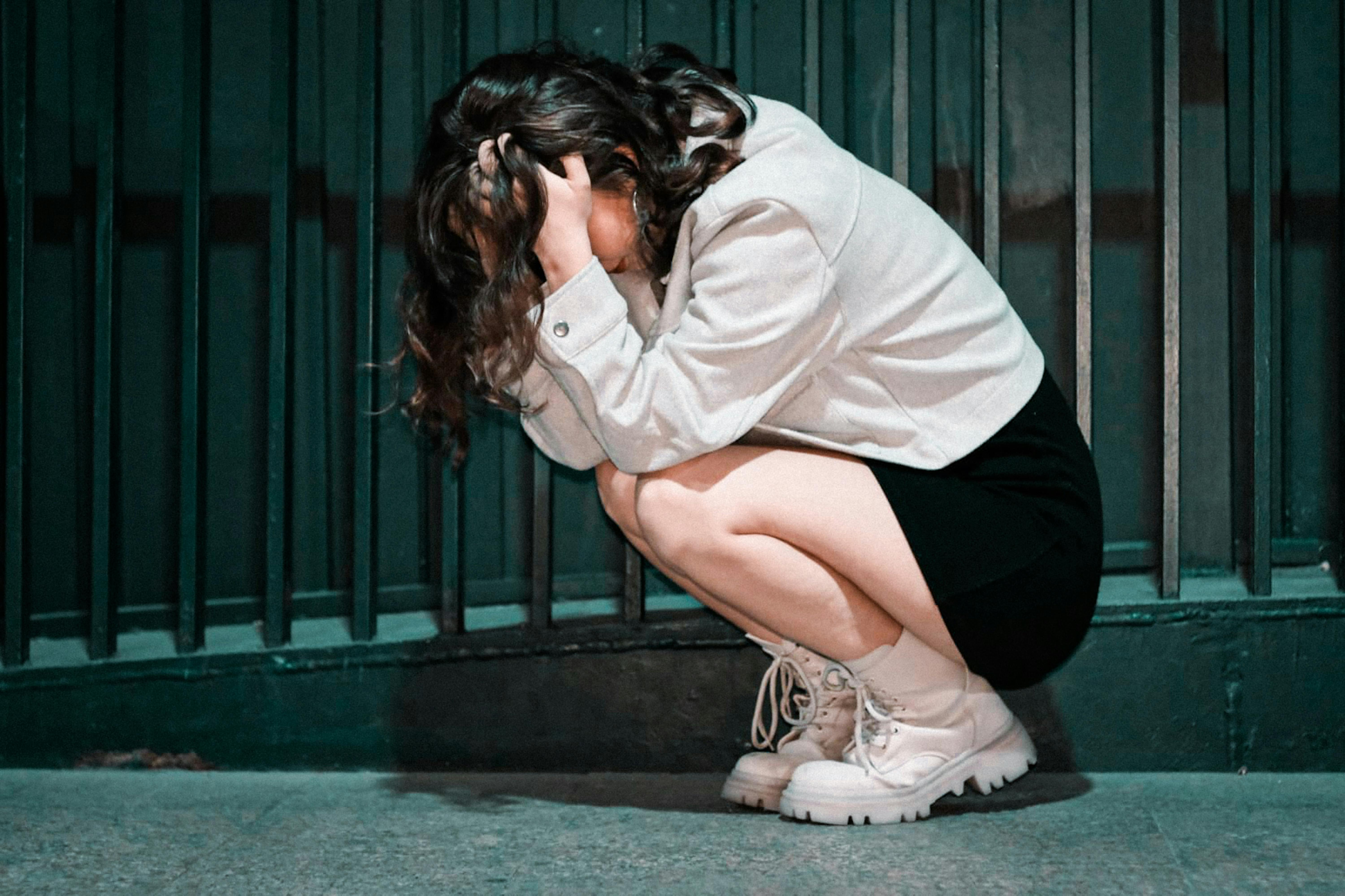 Woman Crouching and Hiding Her Head in Hands · Free Stock Photo