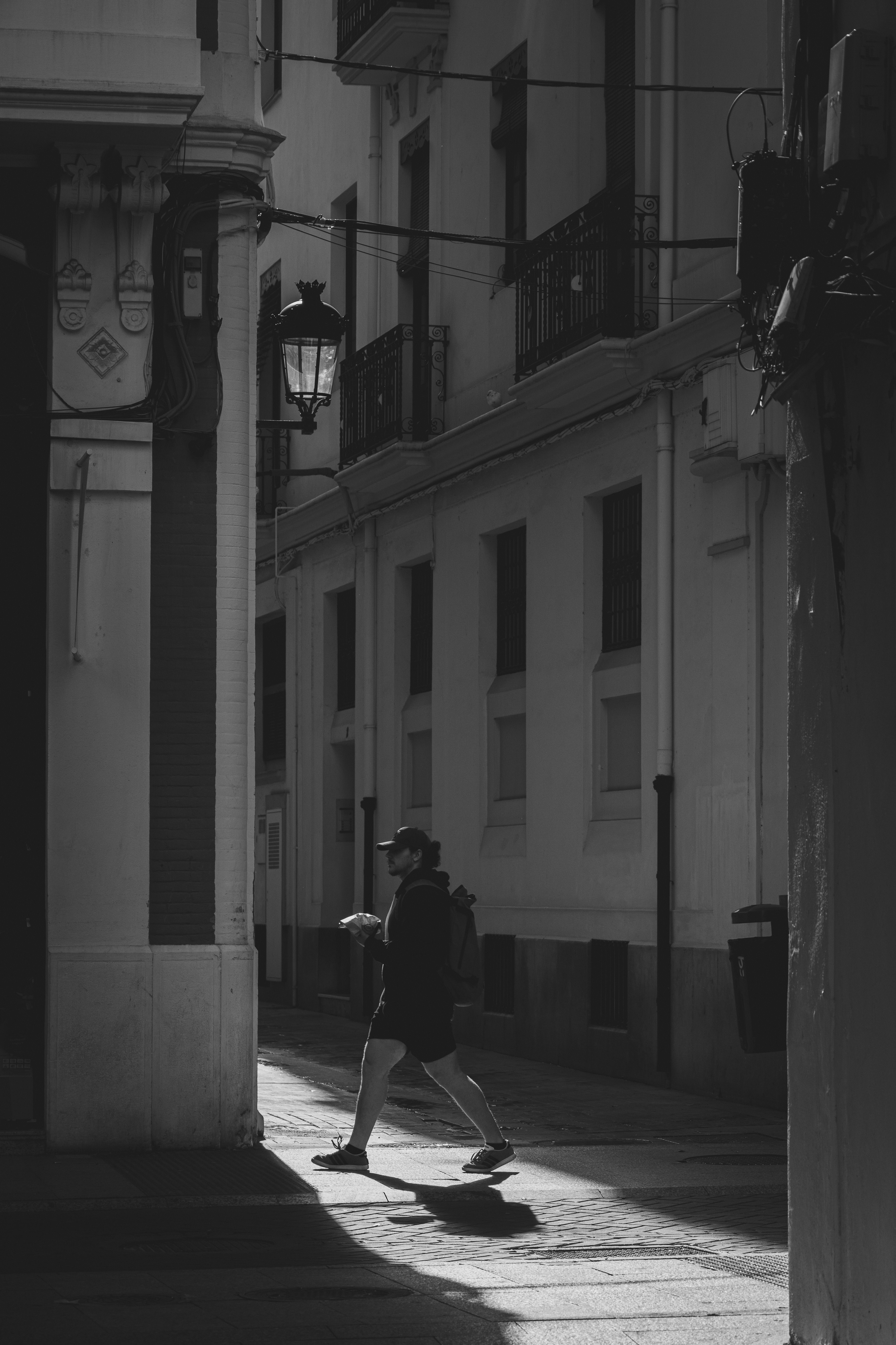 Person Walking Down City Street Alone · Free Stock Photo