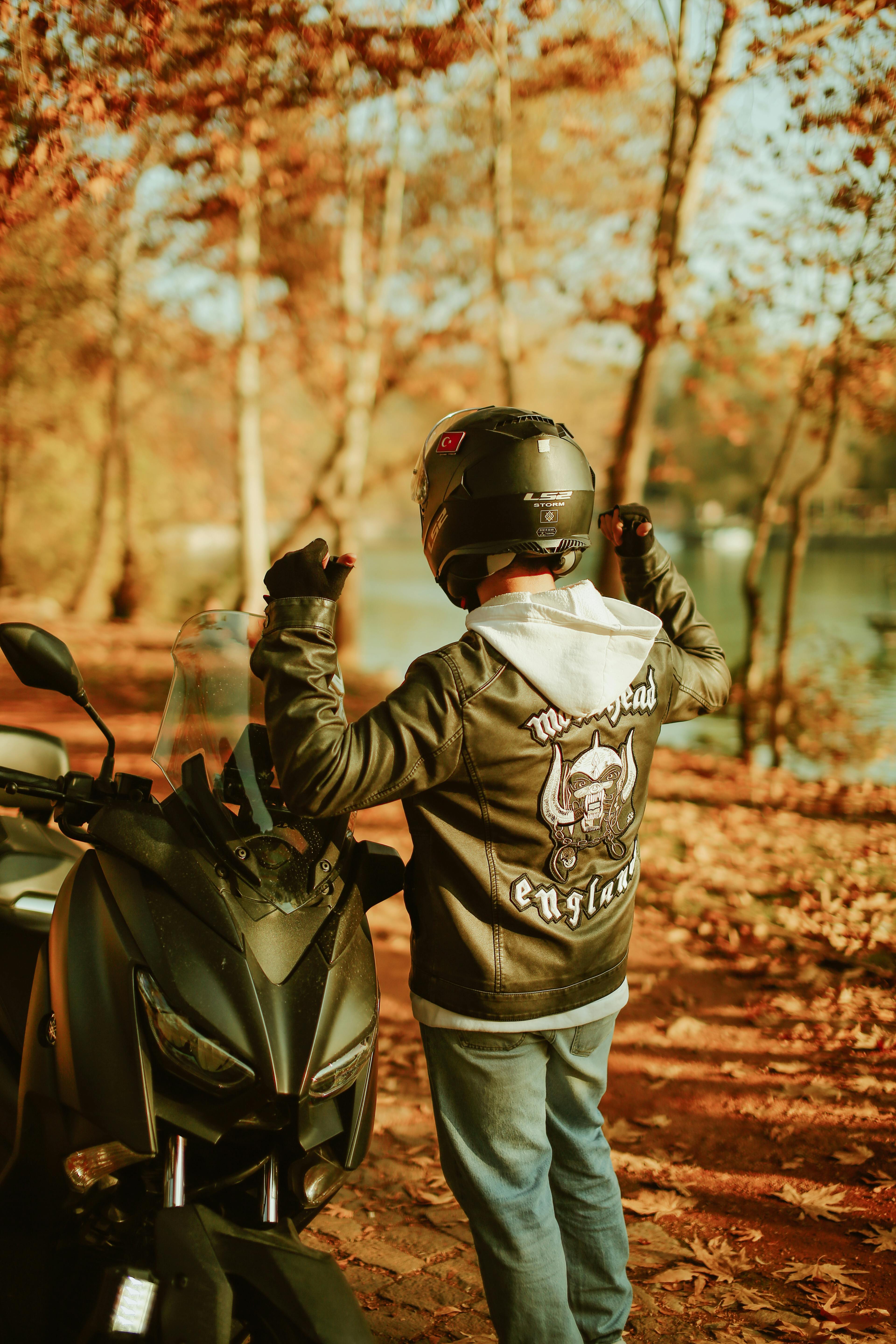 Biker in a Leather Jacket Standing next to his Motorcycle · Free Stock ...