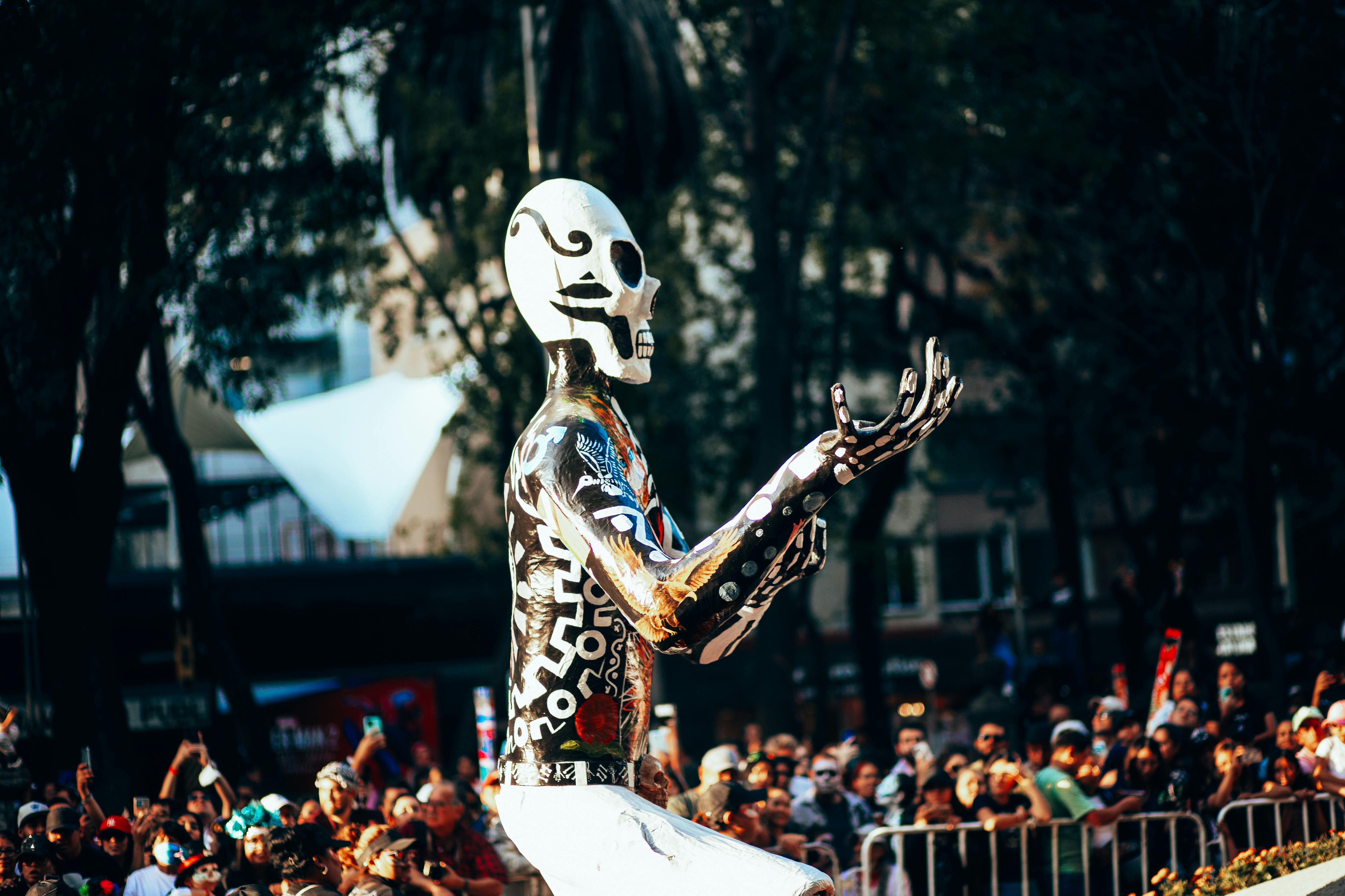 A man dressed in a skeleton costume is standing in front of a crowd ...