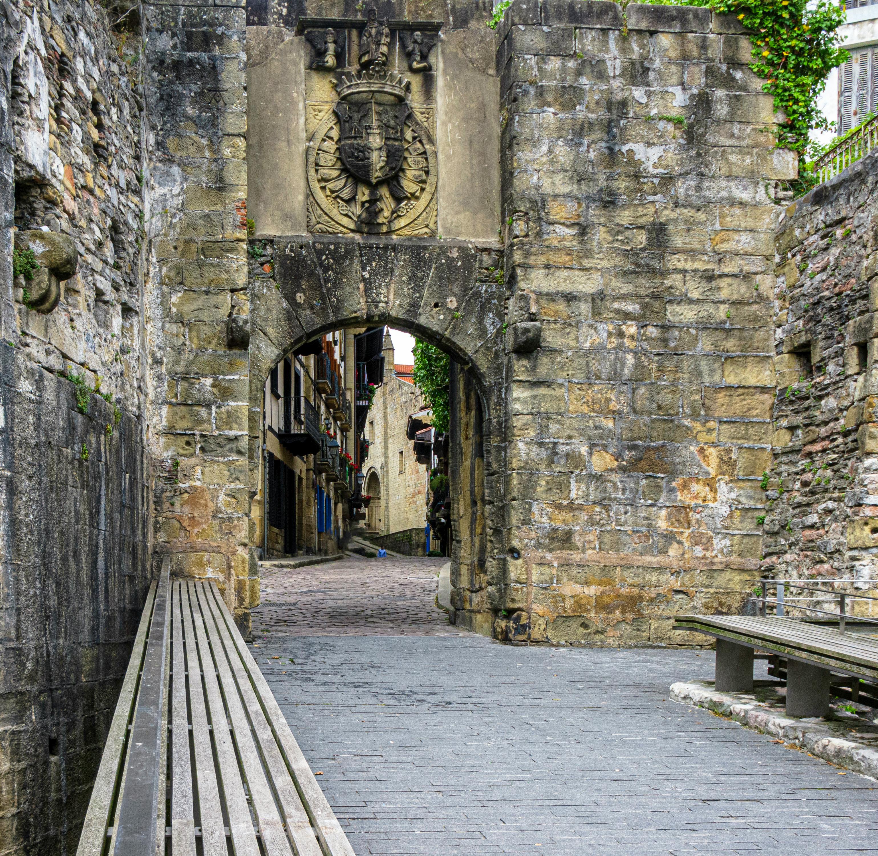 Bench near Medieval, Stone Gate · Free Stock Photo