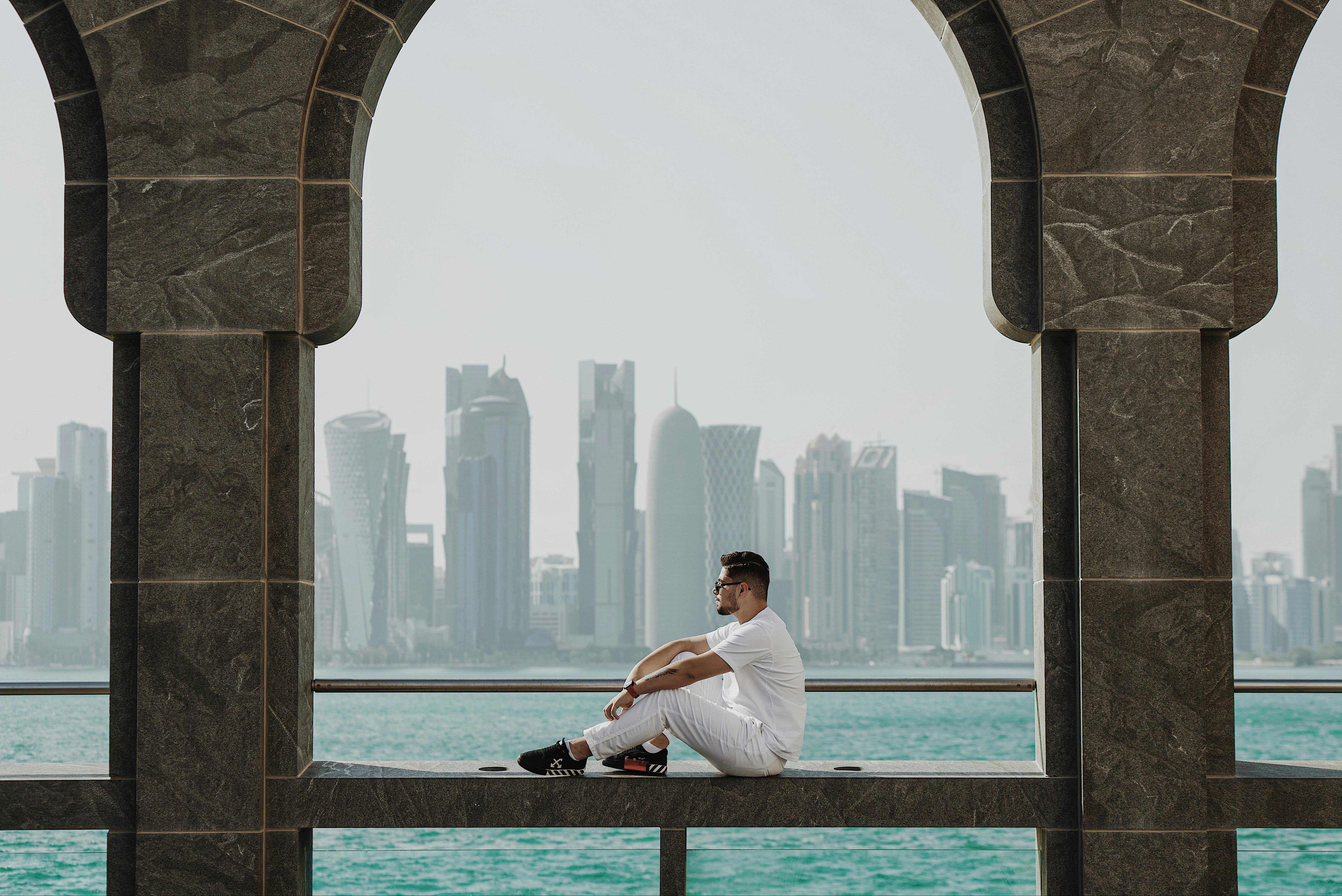 Man Sitting on the Background of a Doha Skyline, Qatar · Free Stock Photo