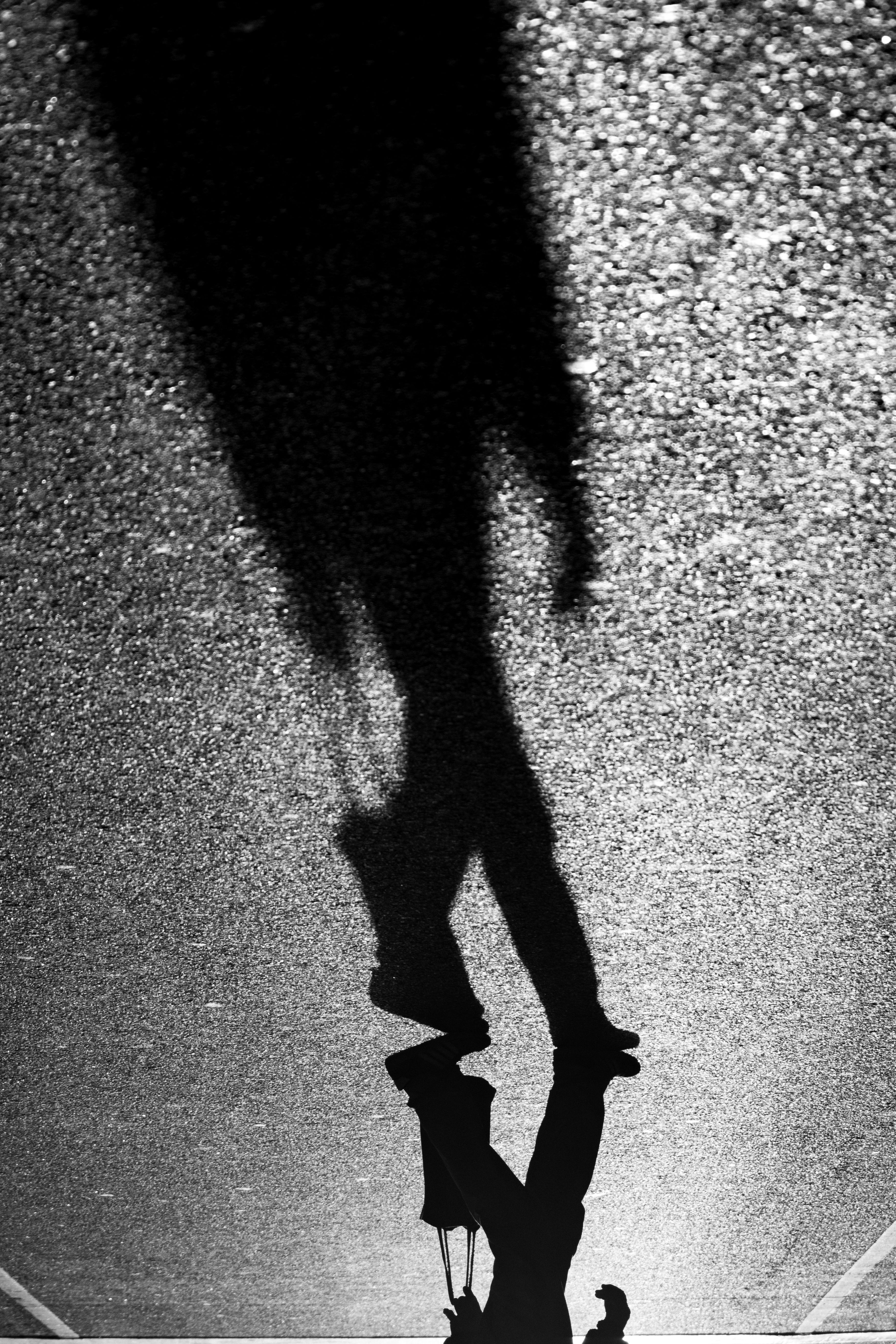 Shadow of Walking Person in Black and White · Free Stock Photo