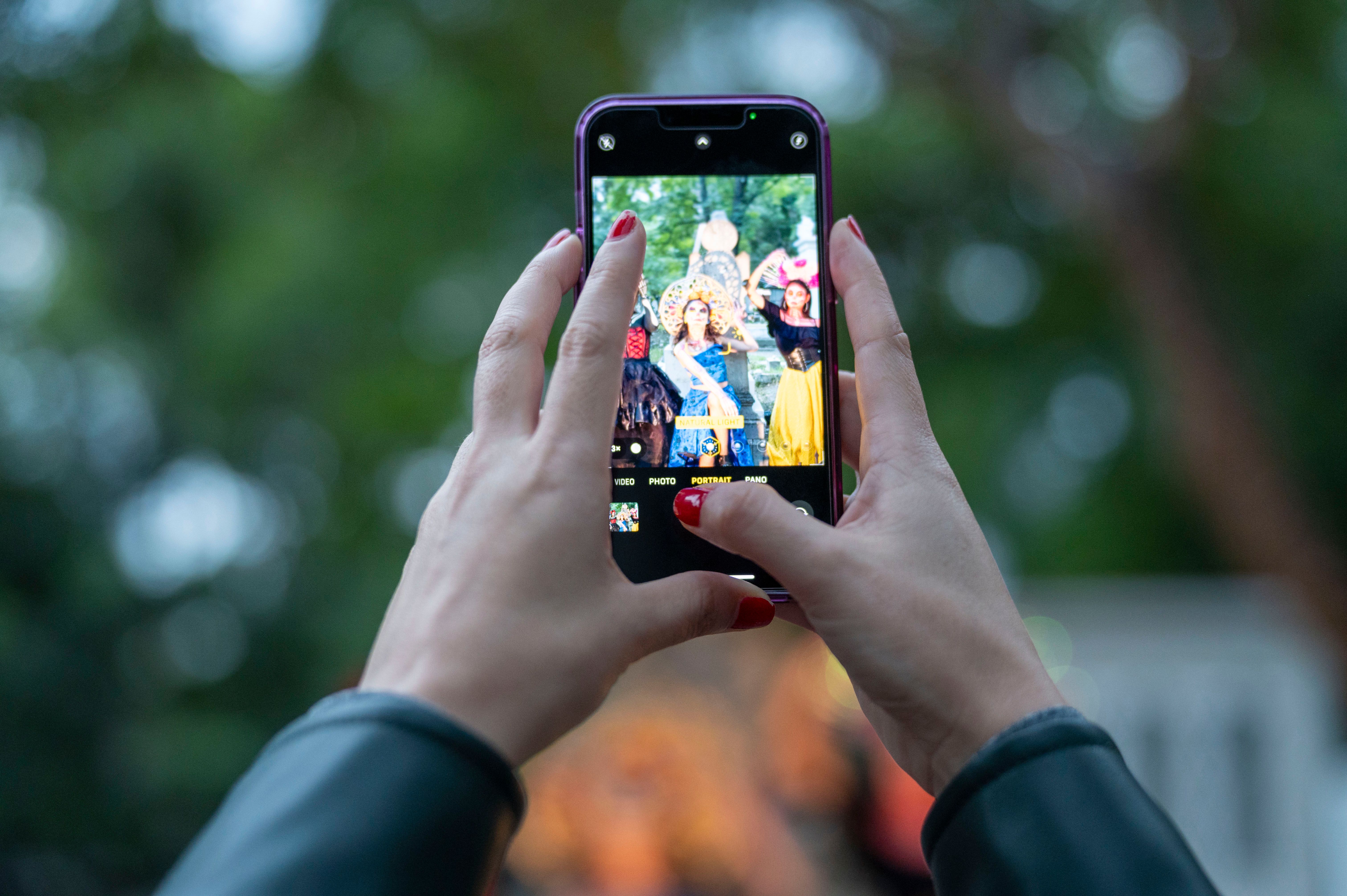 Woman Hands Holding Smartphone and Taking Pictures of Women for Dia de ...
