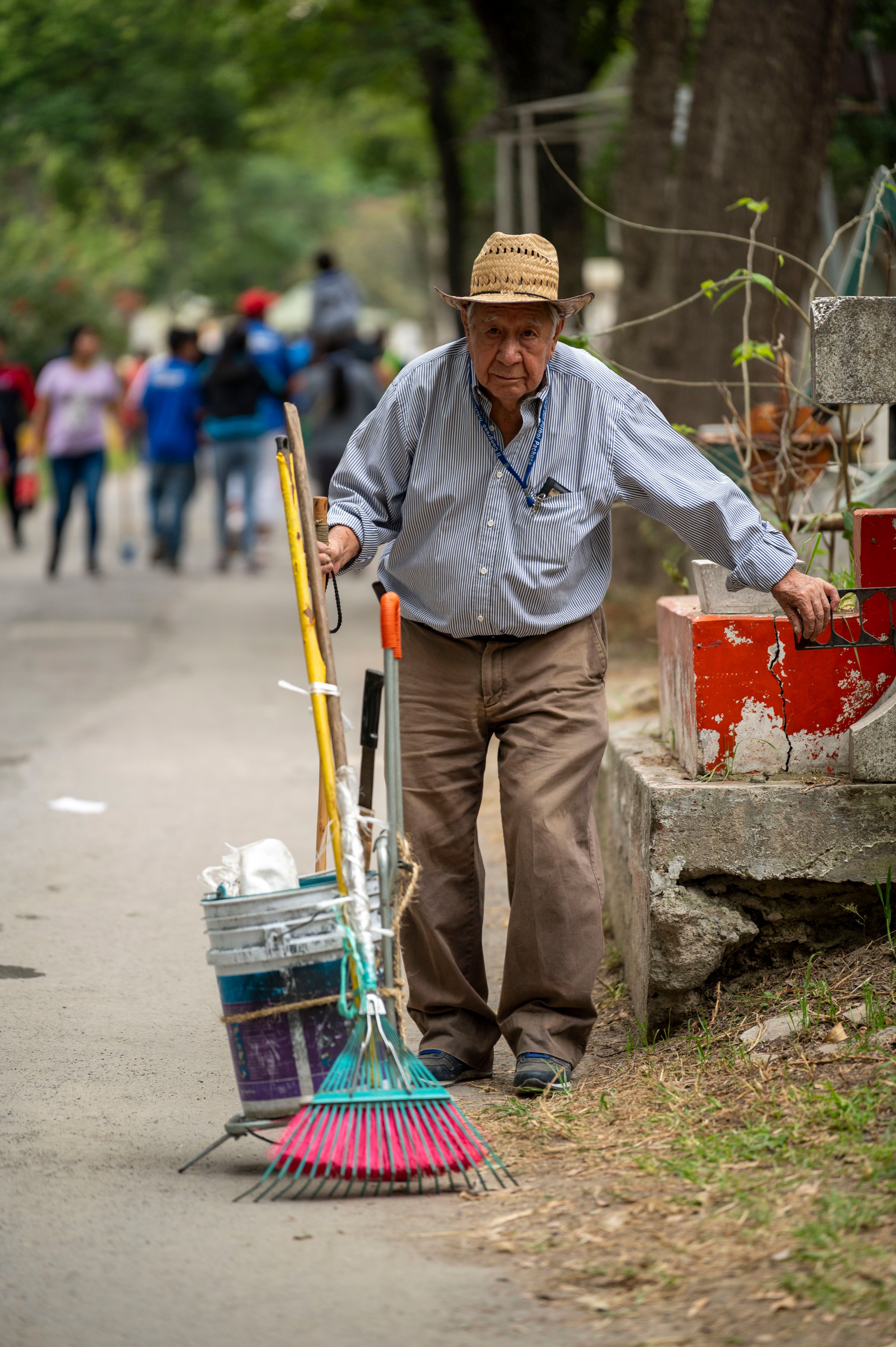 Man with Broom at Cemetery · Free Stock Photo